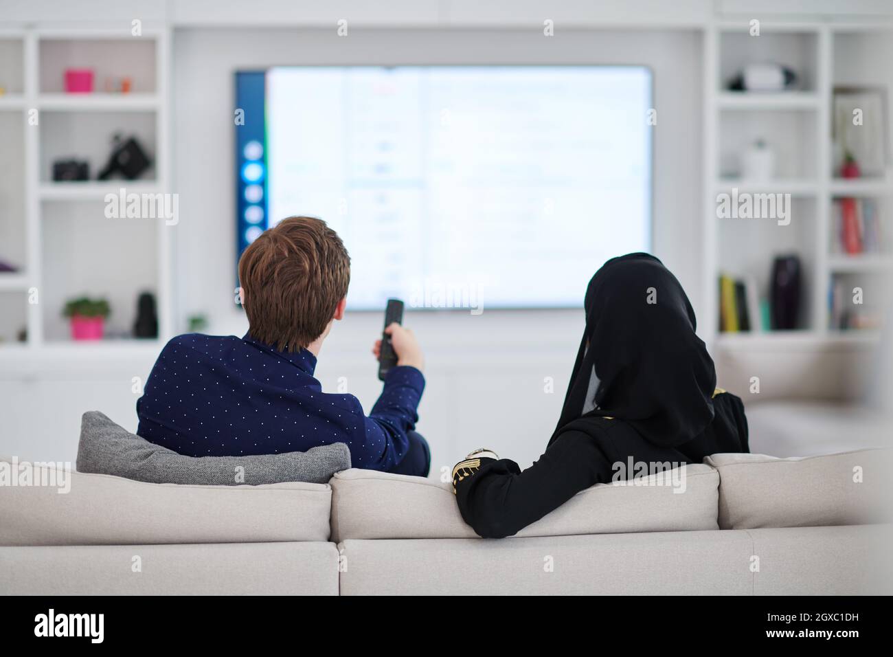 young muslim couple woman wearing islamic hijab clothes sitting on sofa ...