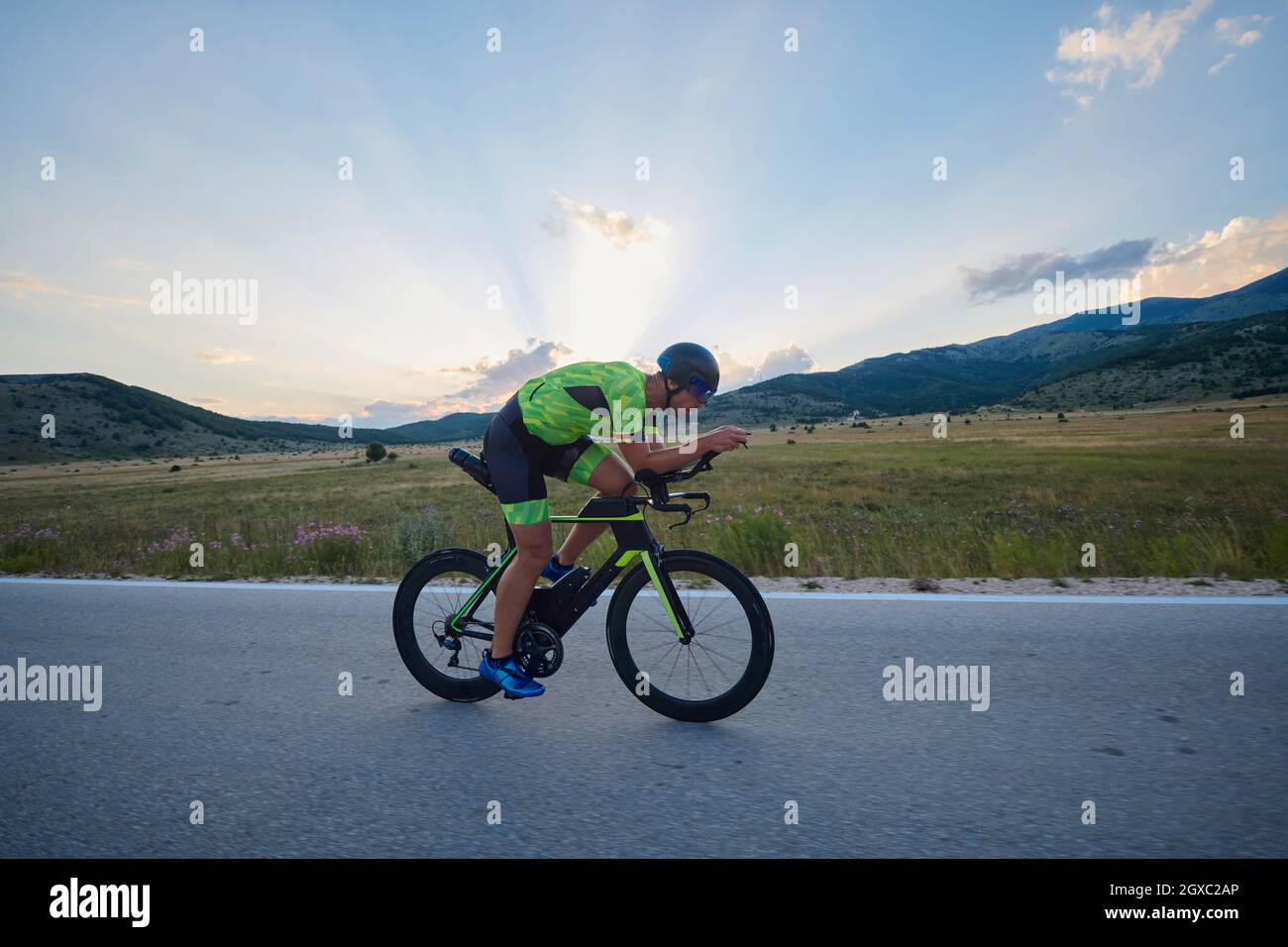 triathlon athlete riding professional racing bike at workout on curvy country road Stock Photo ...