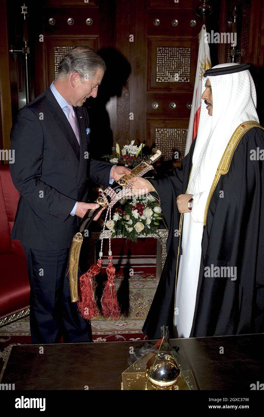 Prince Charles, Prince of Wales receives an ornate sword from the King ...