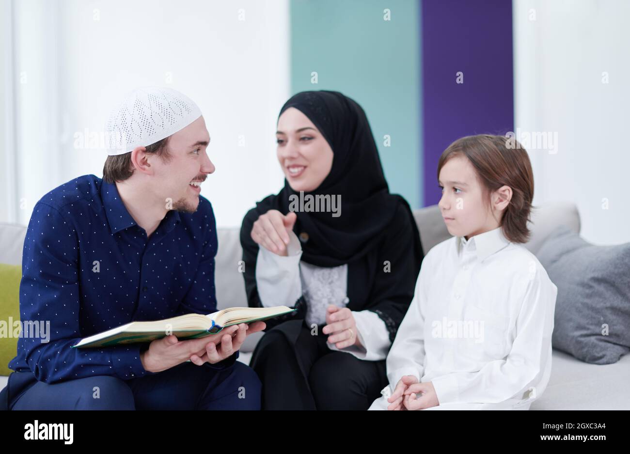 Traditional muslim family parents with children reading Quran and ...
