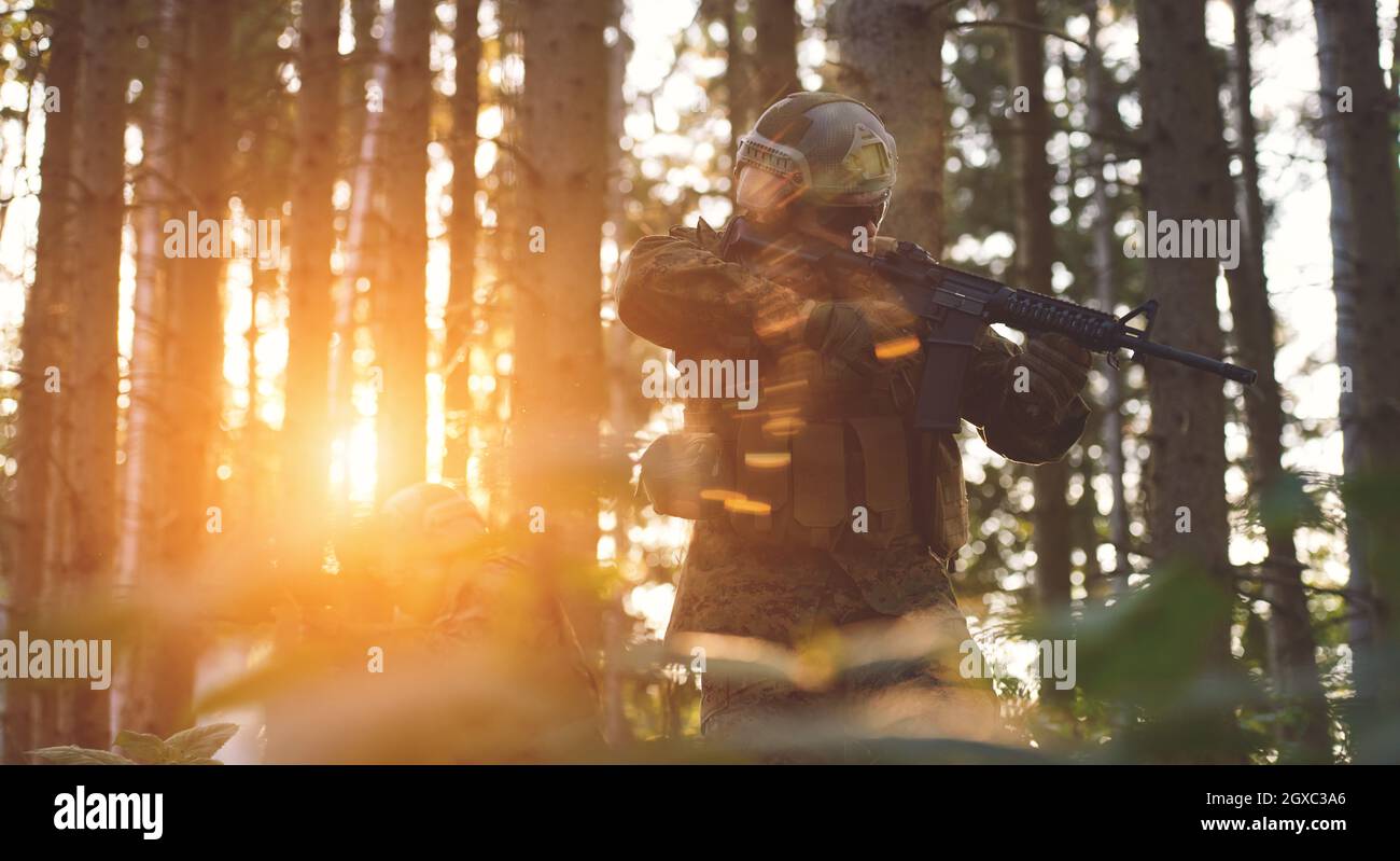 modern warfare soldier in action aiming at weapon laser sight optics in ...