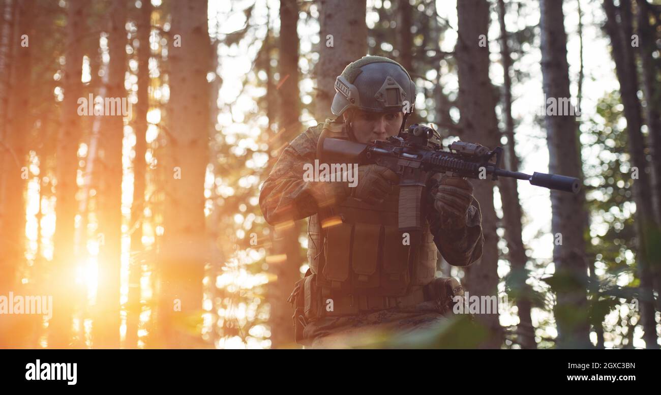 modern warfare soldier in action aiming at weapon laser sight optics in ...