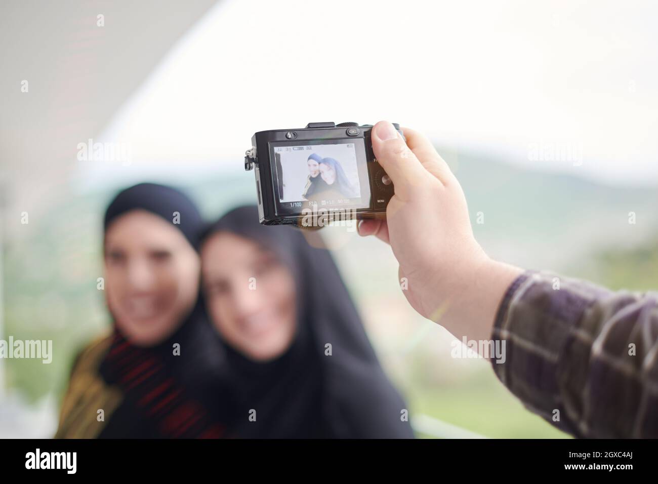professional photographer taking photo with camera of young beautiful ...