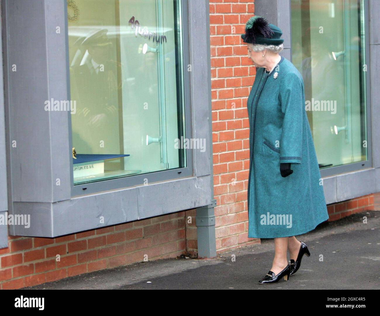 Queen Elizabeth II looks at window displays which are part of the ...