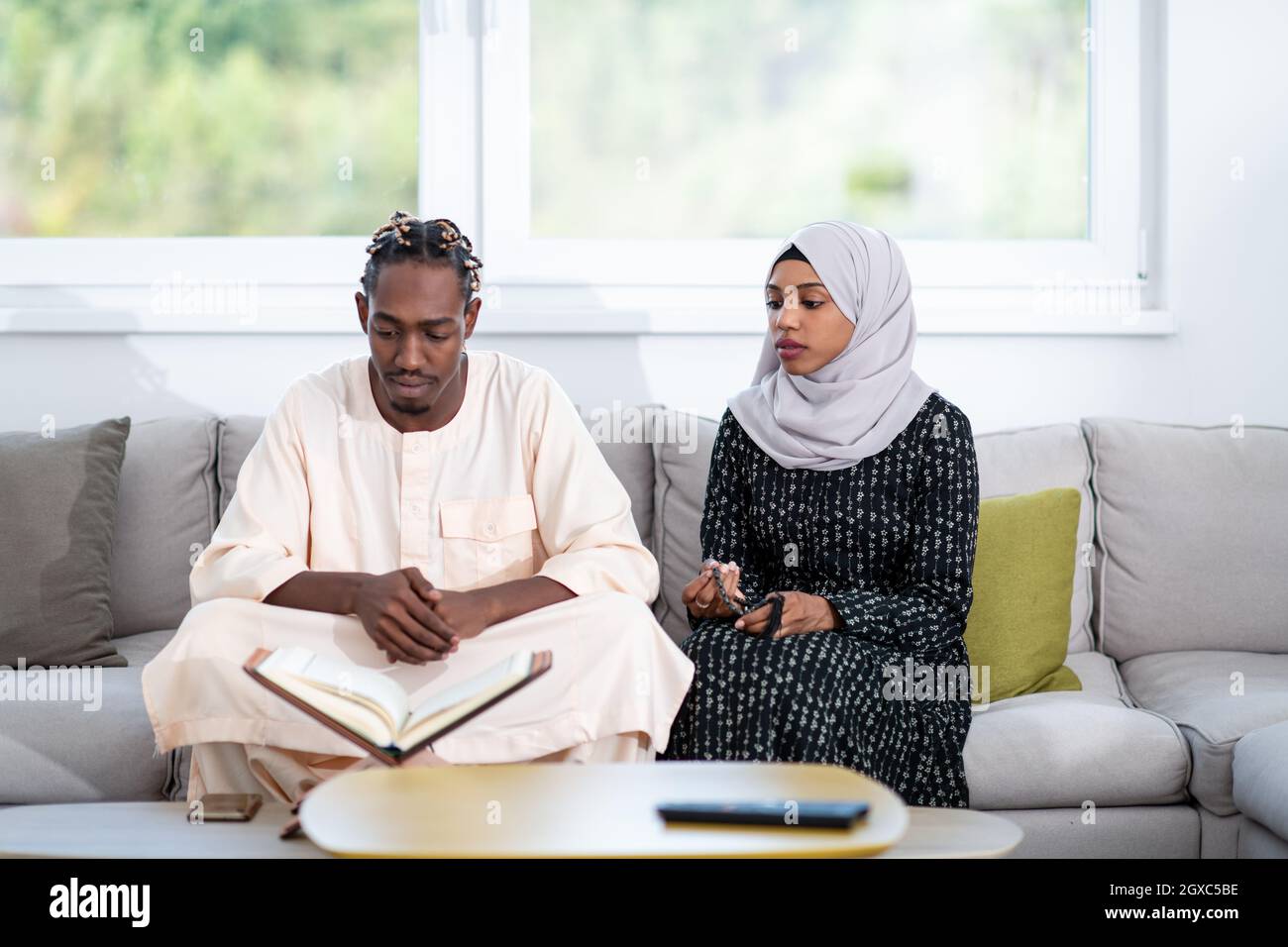 african muslim couple at home in ramadan reading quran holly islam book ...