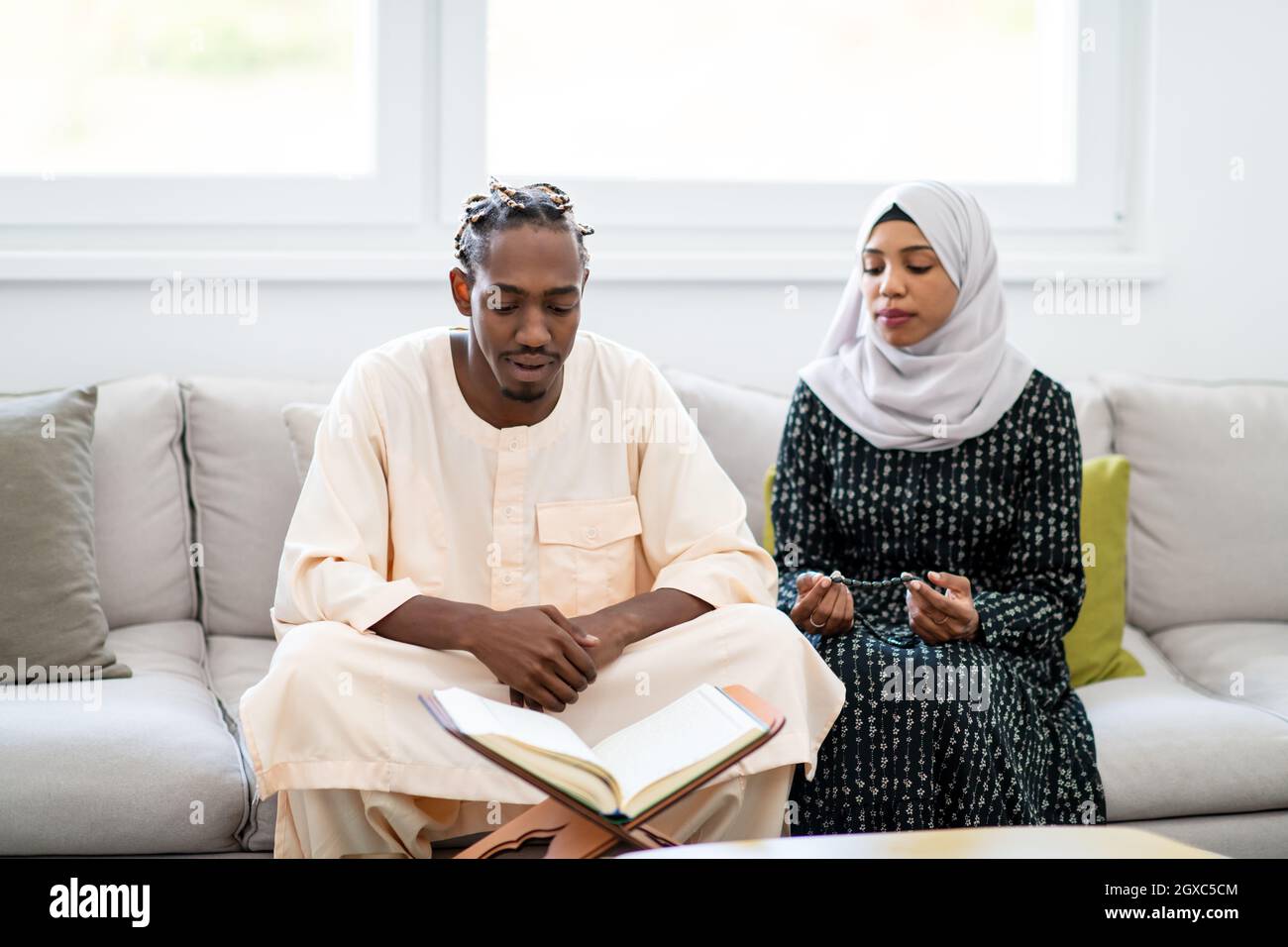 african muslim couple at home in ramadan reading quran holly islam book ...