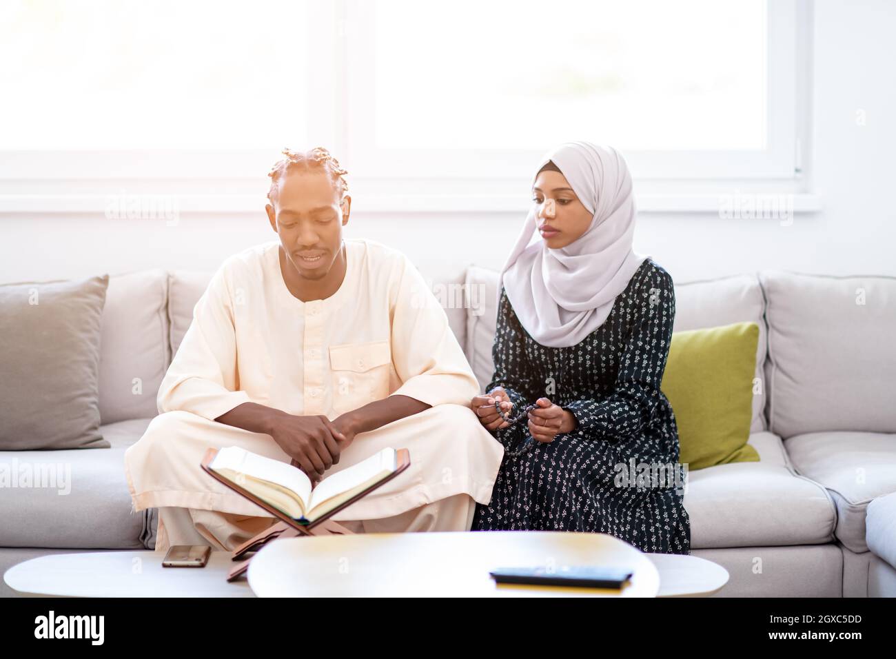 african muslim couple at home in ramadan reading quran holly islam book ...