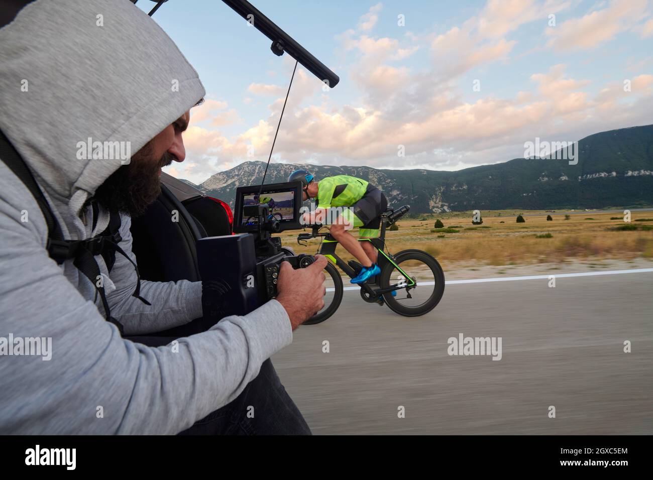 cinematographer with professional cinema camera taking sport action ...