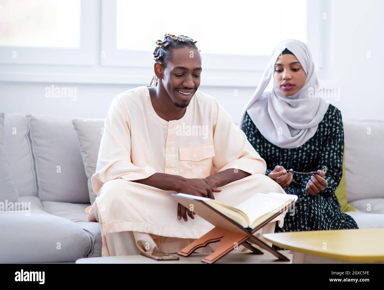 african muslim couple at home in ramadan reading quran holly islam book ...