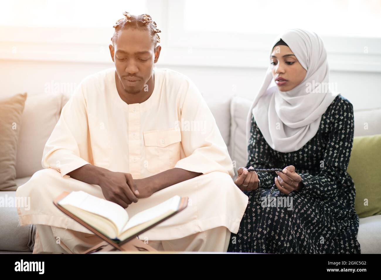 african muslim couple at home in ramadan reading quran holly islam book ...
