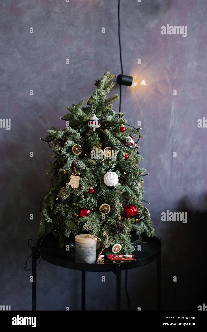 Small Christmas tree on a small table in interior design Stock Photo ...
