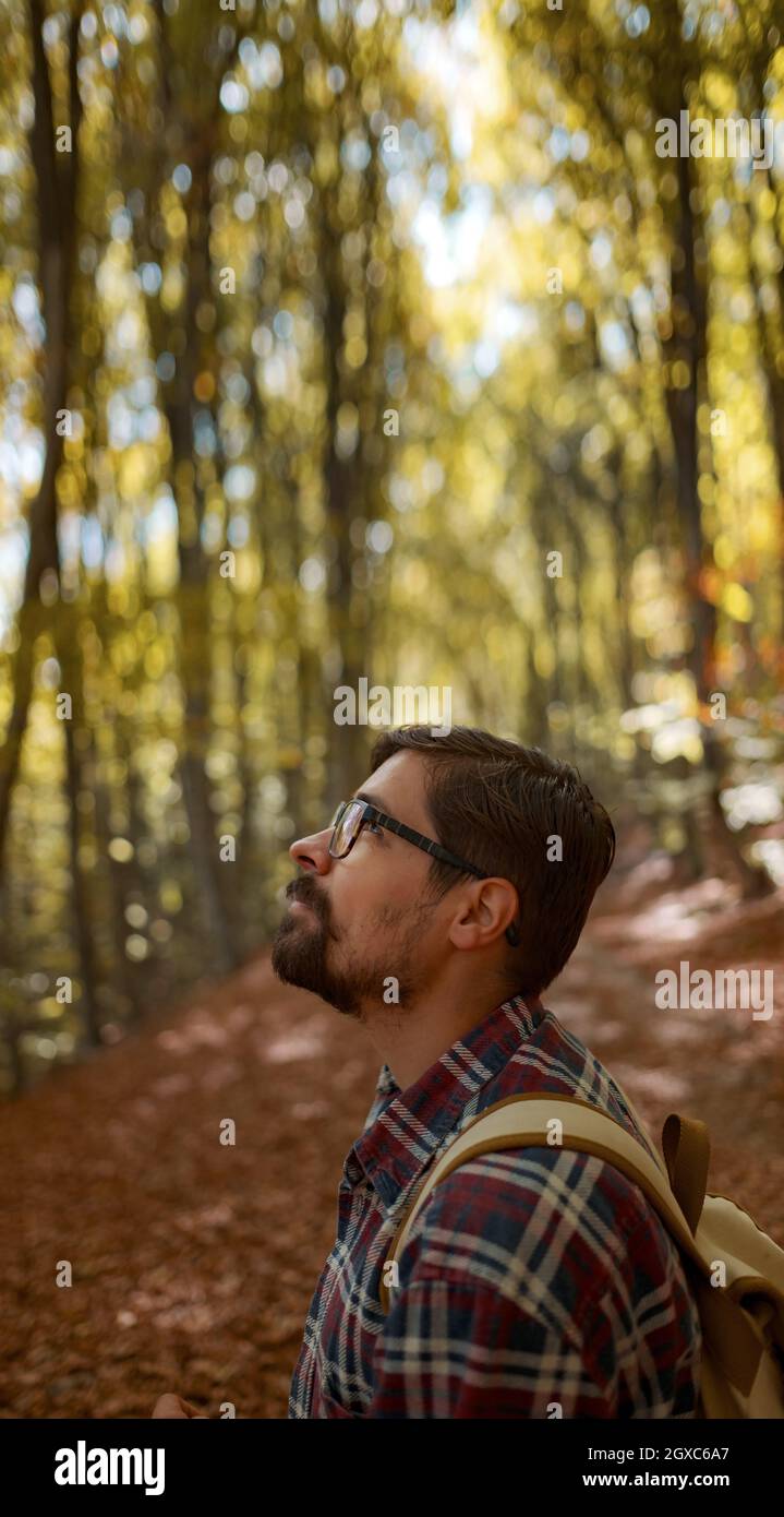Caucasian hipster male model outdoors in nature. Colorful landscape ...