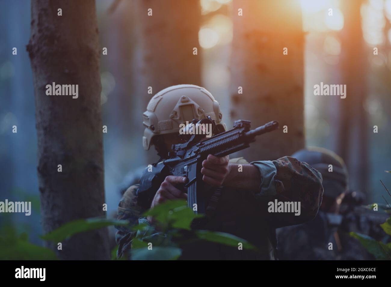 modern warfare soldier in action aiming at weapon laser sight optics in ...