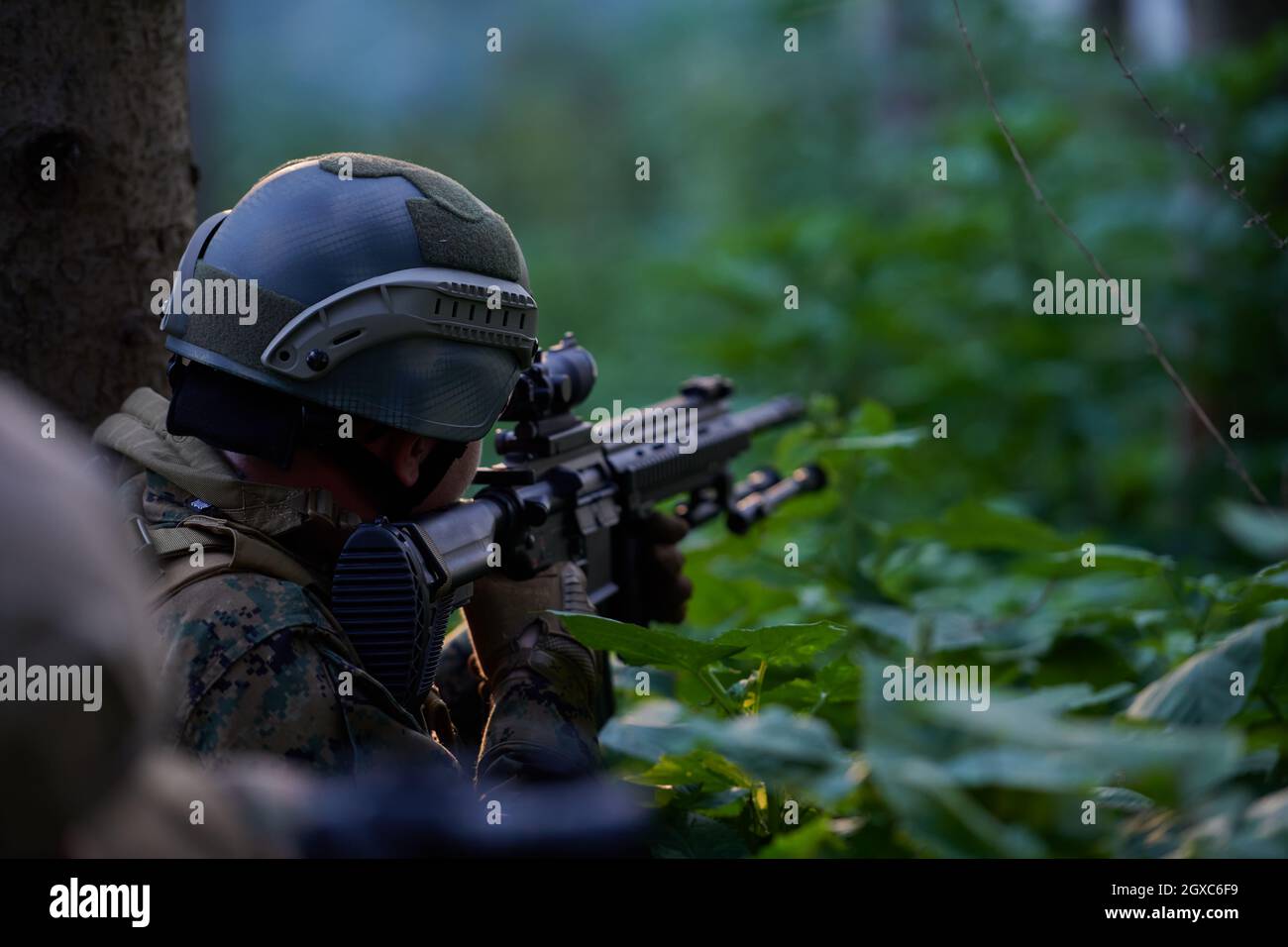 modern warfare soldier in action aiming at weapon laser sight optics in ...