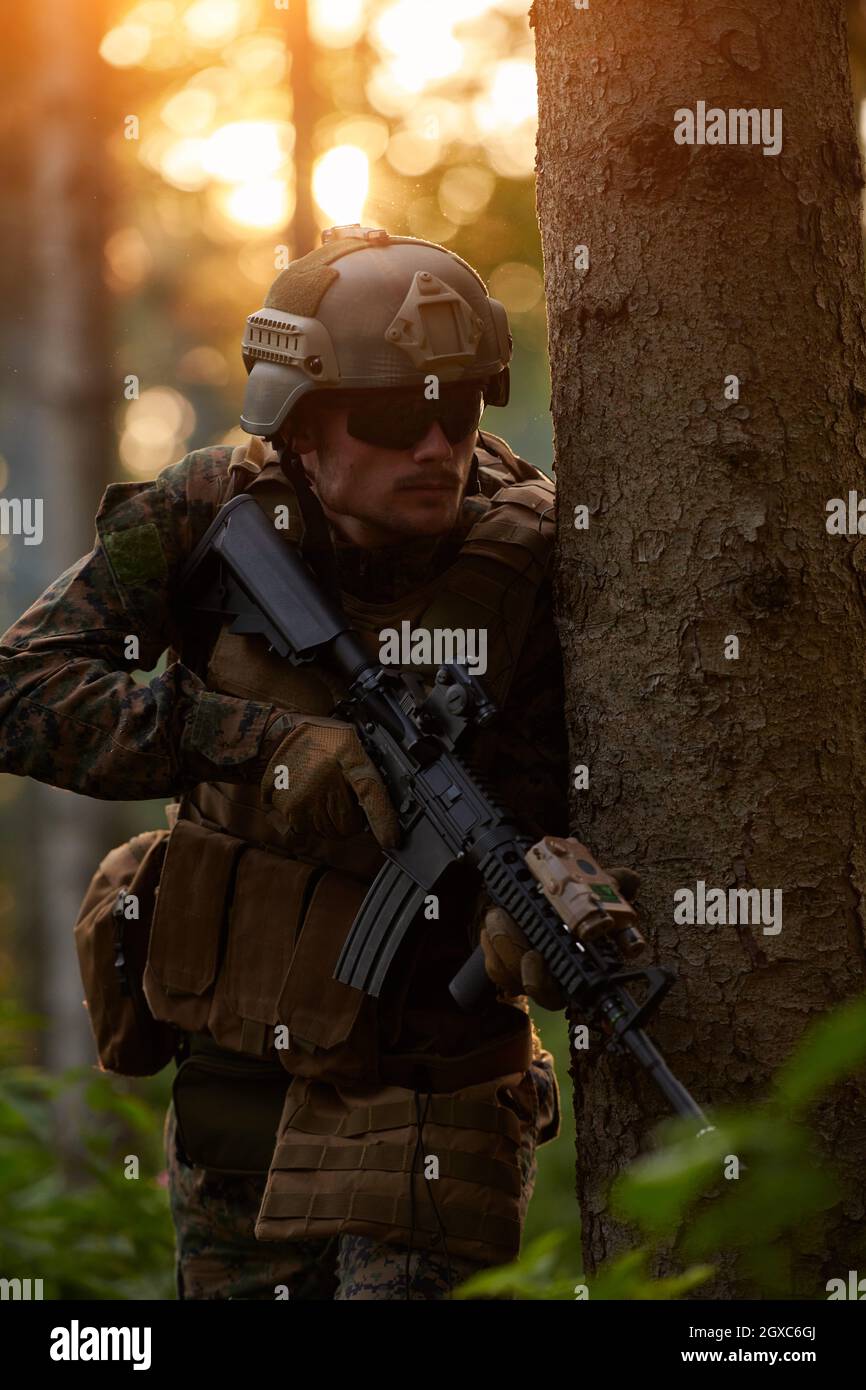 modern warfare soldier in action aiming at weapon laser sight optics in ...