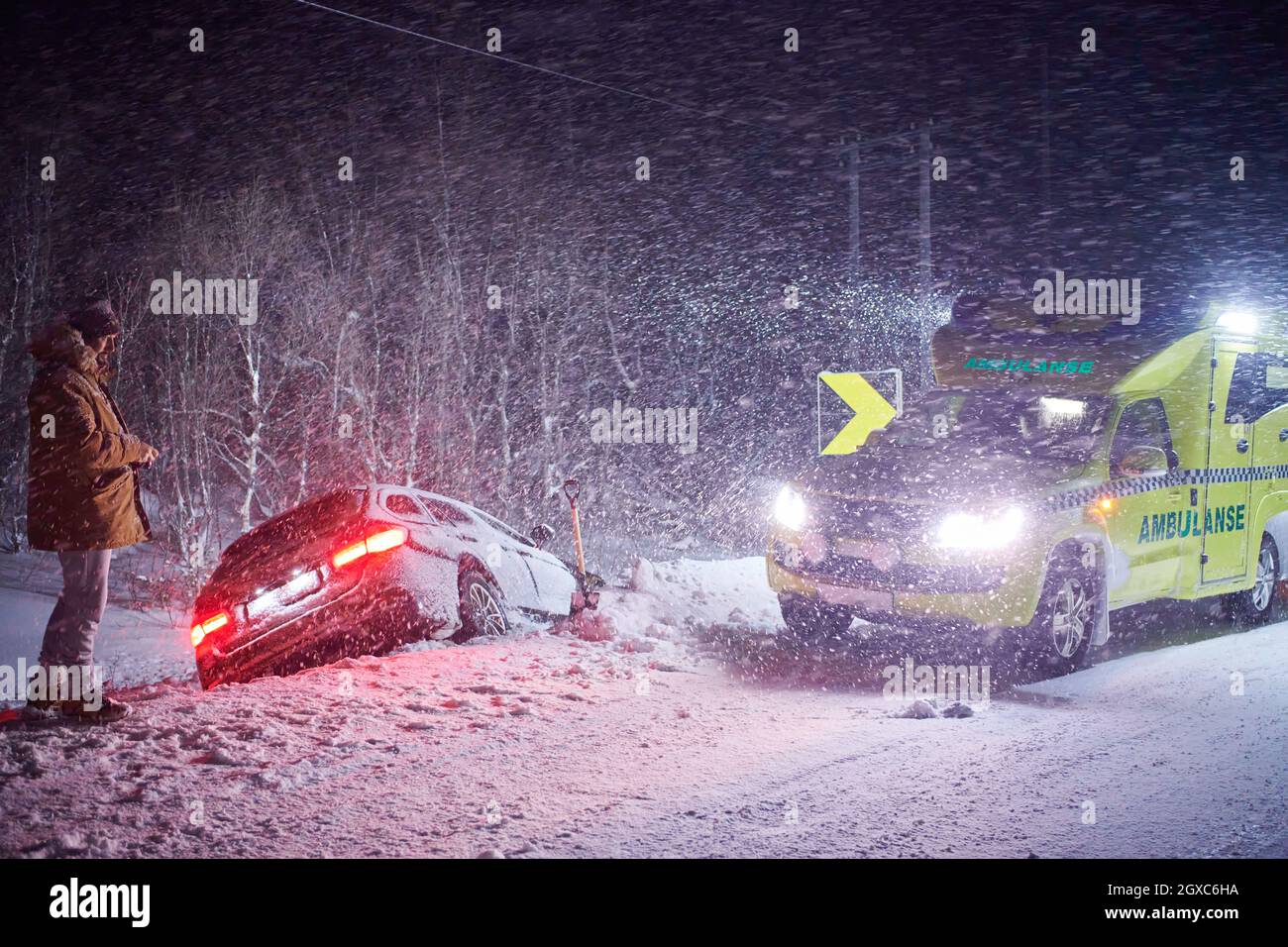 car accident on slippery winter road at night with heavy snow fall and ...
