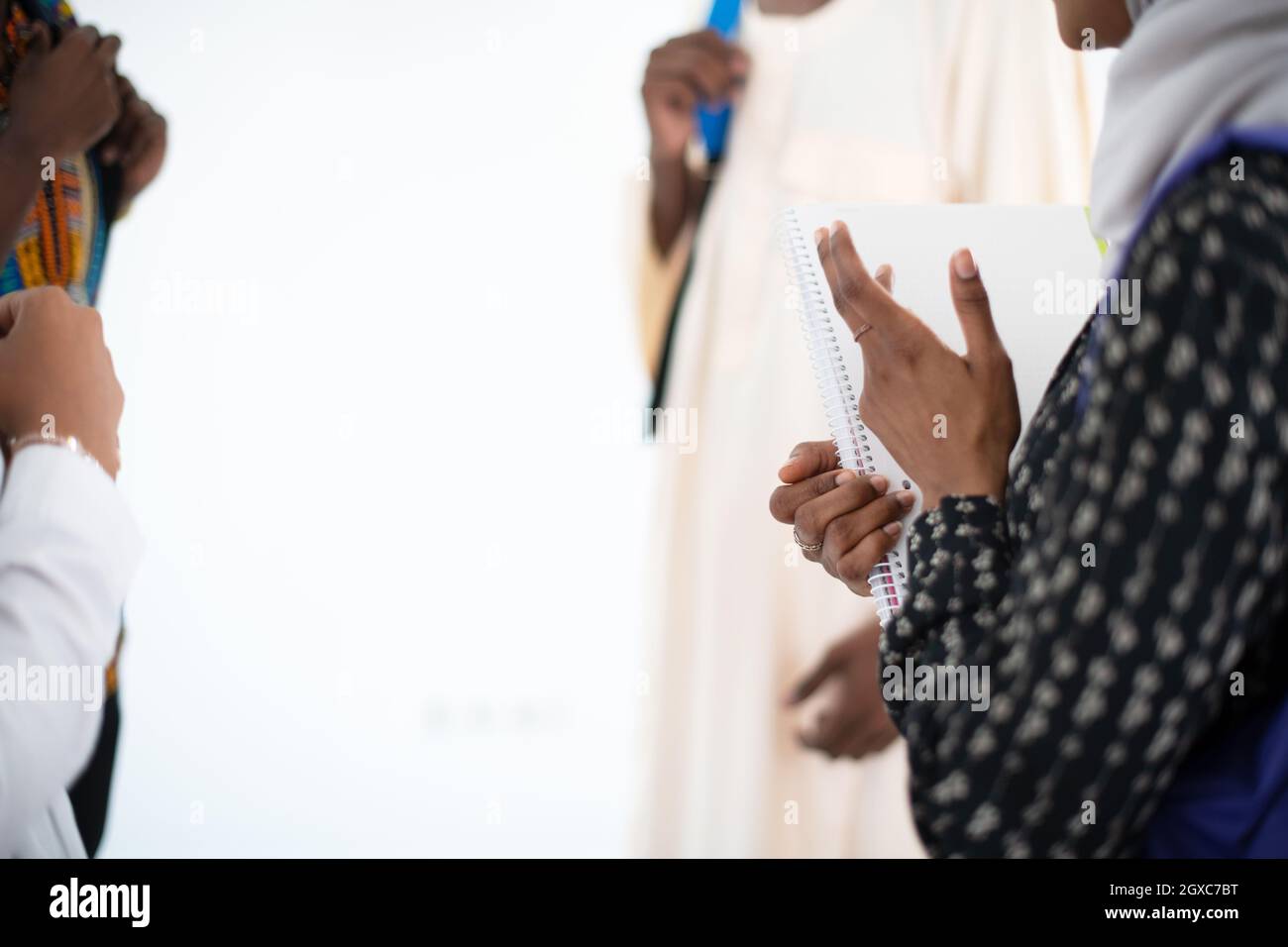 group of happy african students having conversation and team meeting ...