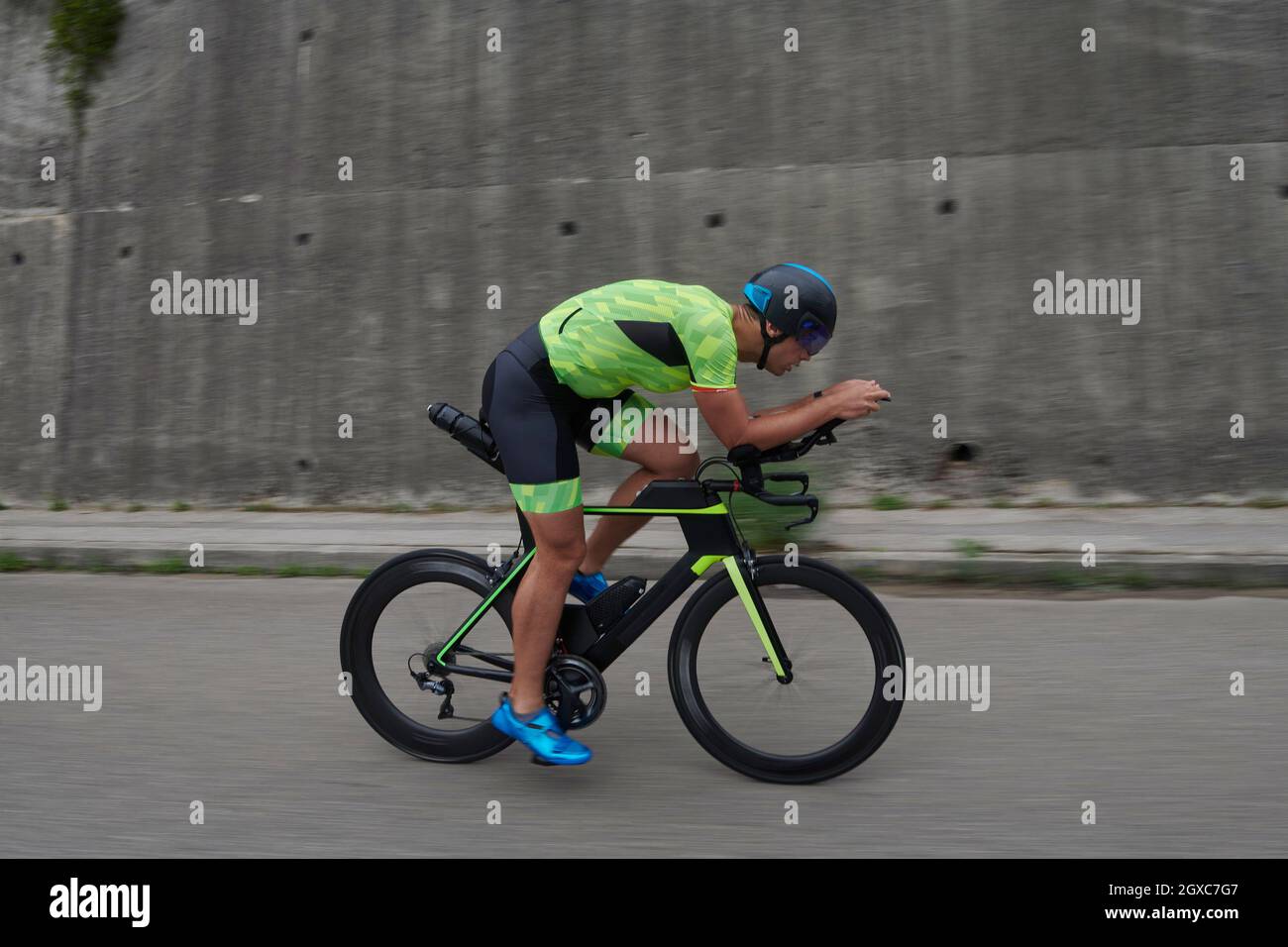 triathlon athlete riding racing bike on morning training urban ...