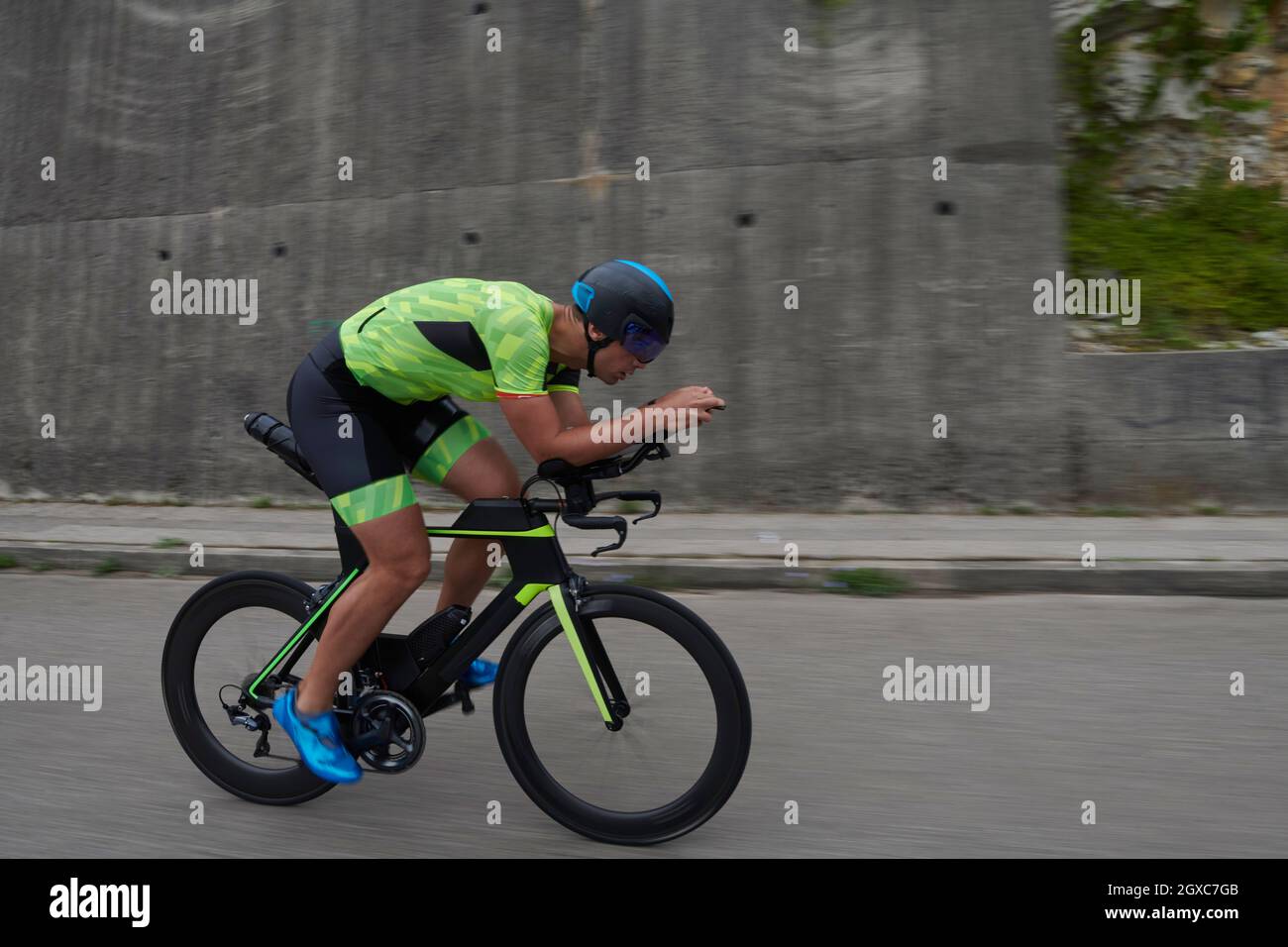 triathlon athlete riding racing bike on morning training urban enviroment Stock Photo - Alamy