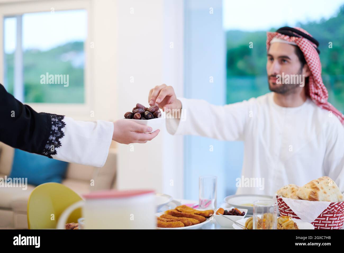 Eid Mubarak Muslim family having Iftar dinner eating dates to break ...