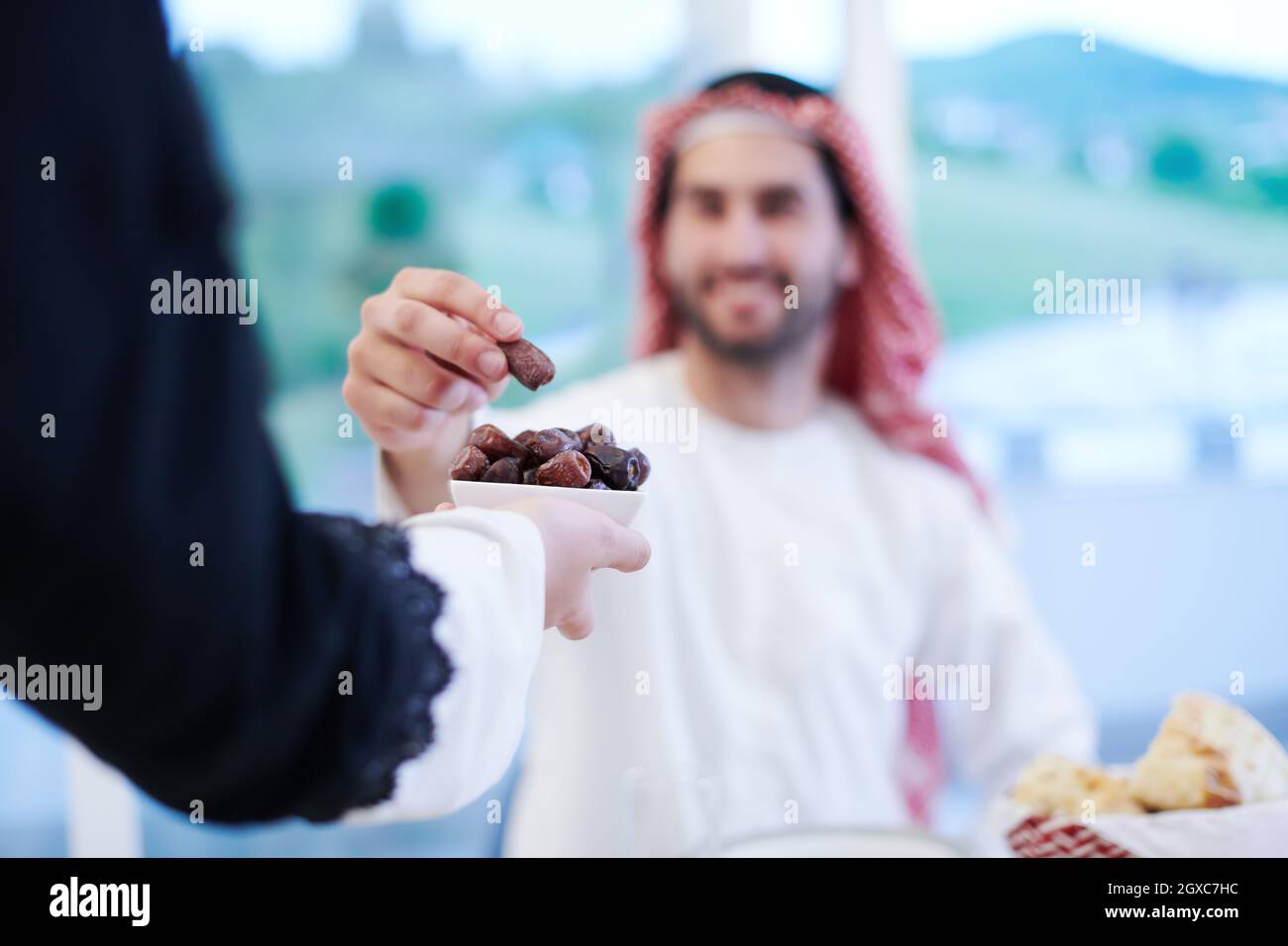 Eid Mubarak Muslim family having Iftar dinner eating dates to break ...
