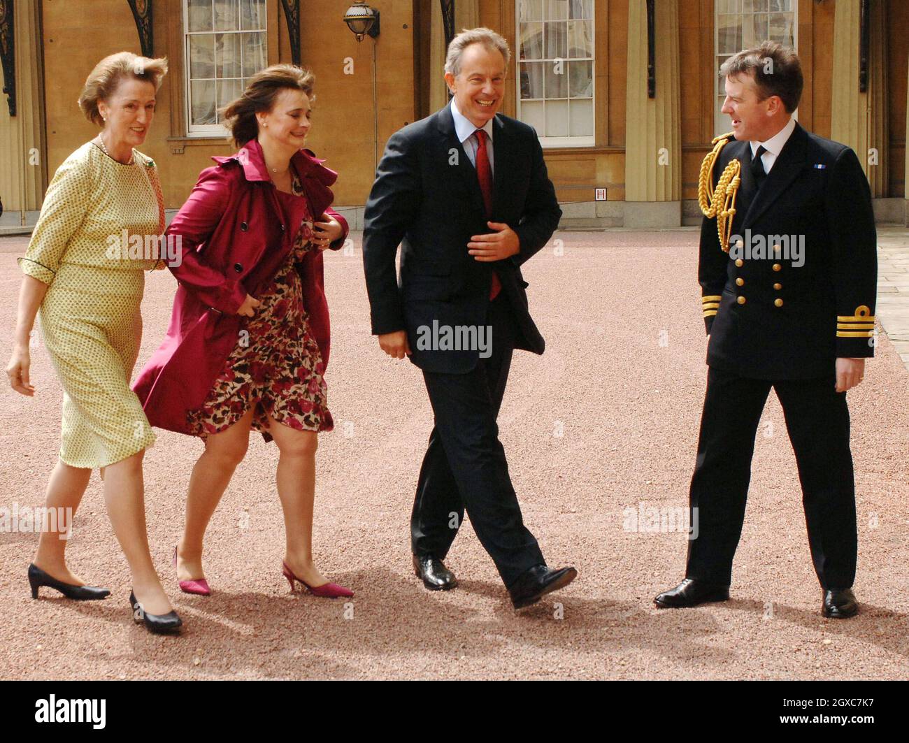 Prime Minister Tony Blair, accompanied by wife Cherie, is greeted by ...