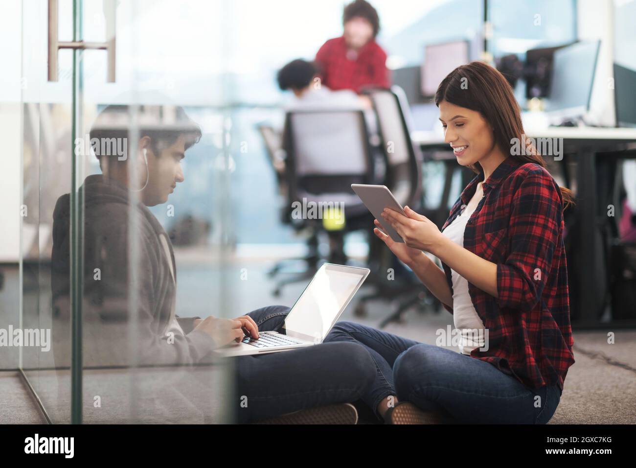 young software developers couple using laptop computer writing ...