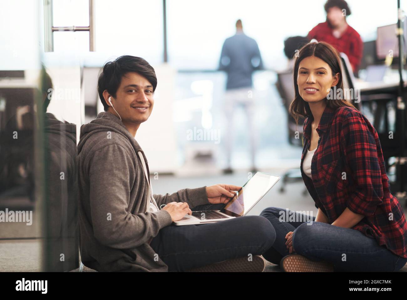 young software developers couple using laptop computer writing ...