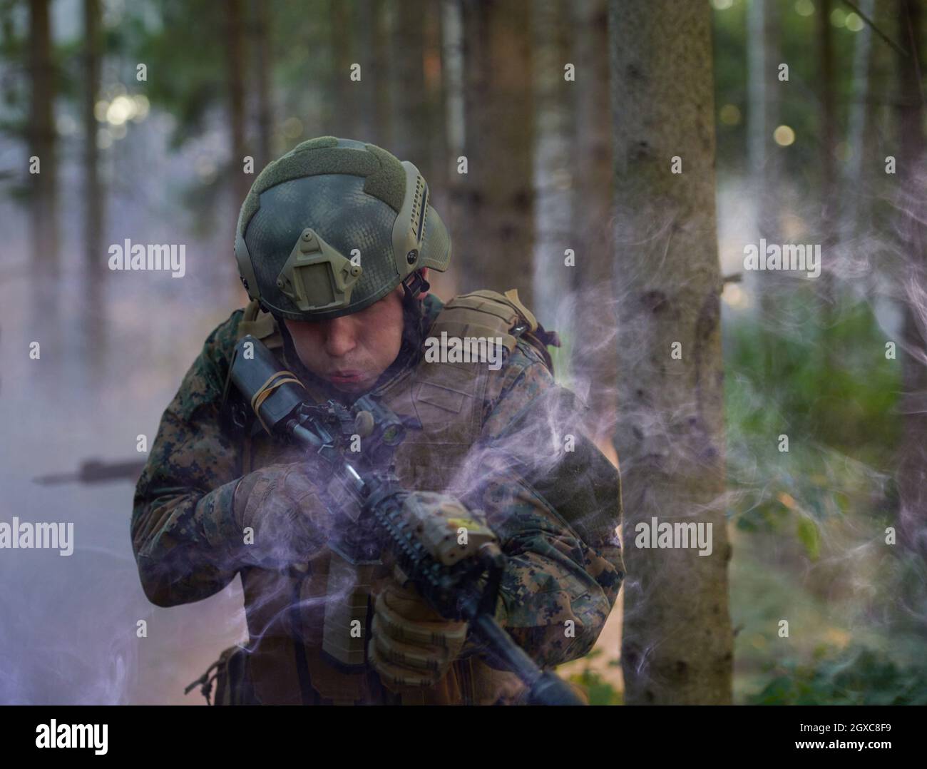 modern warfare soldier in action aiming at weapon laser sight optics in ...