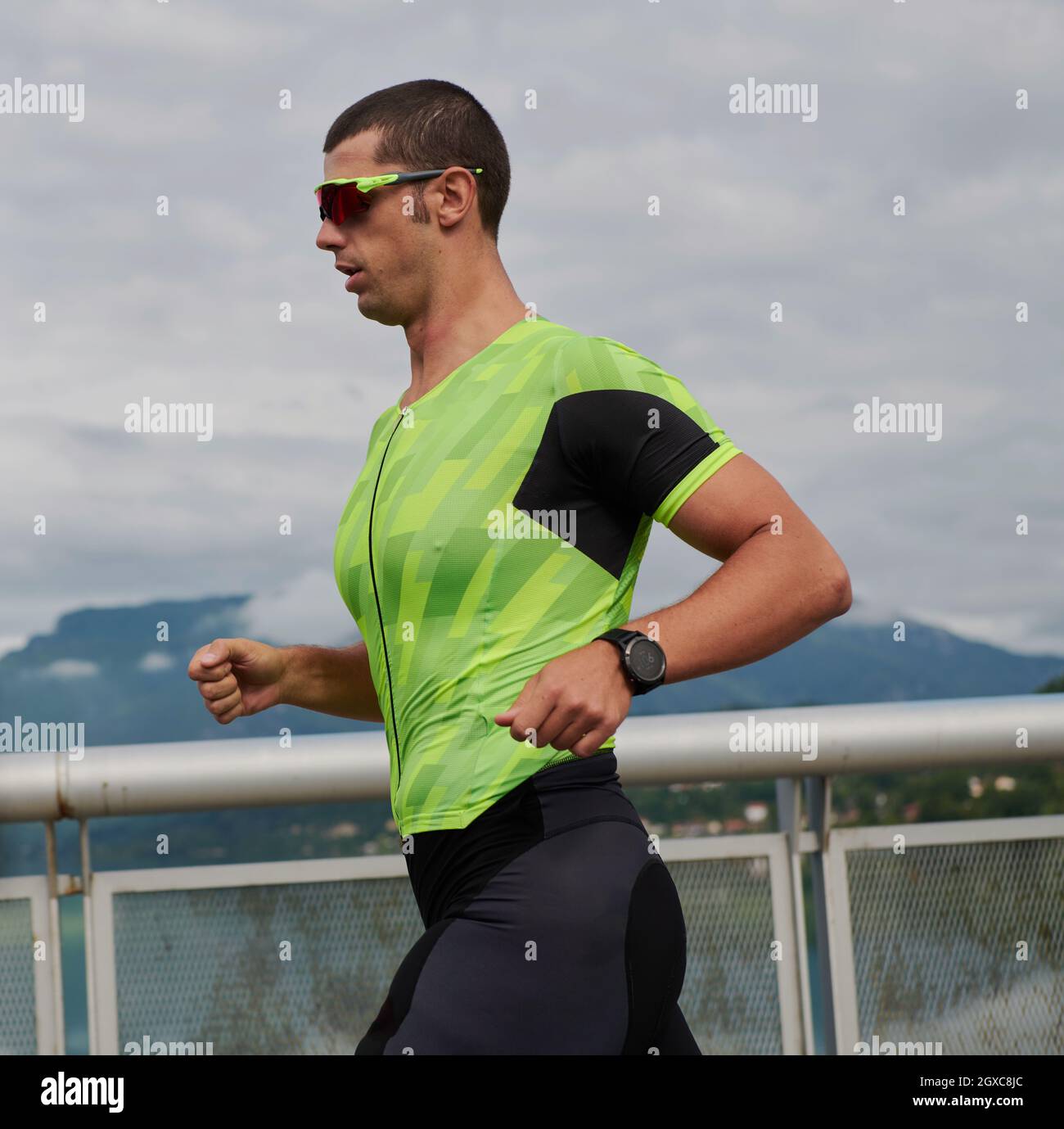 triathlon athlete running on street urban enviroment morning training ...