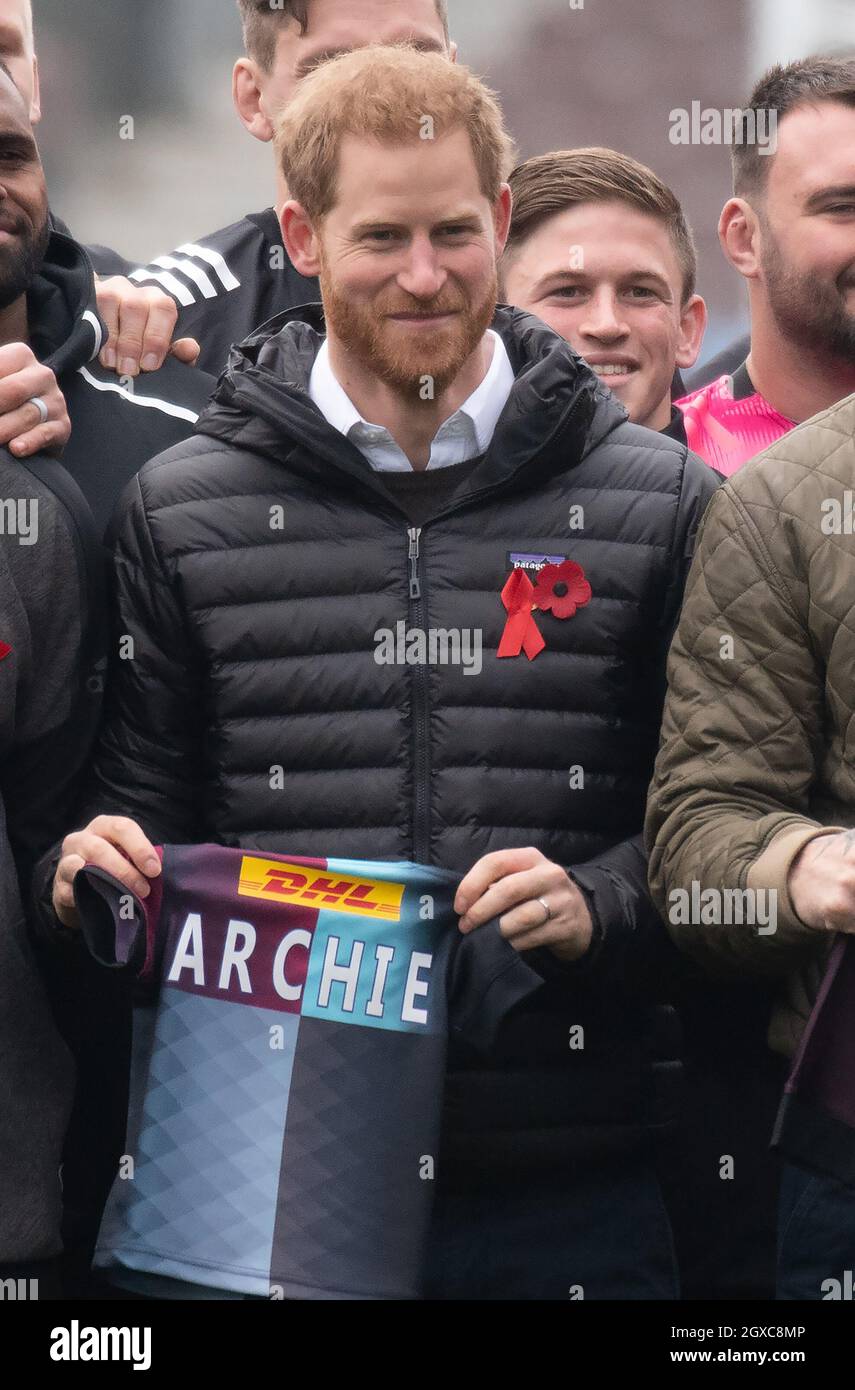 Prince Harry, Duke of Sussex is presented with a tiny Harlequins kit ...