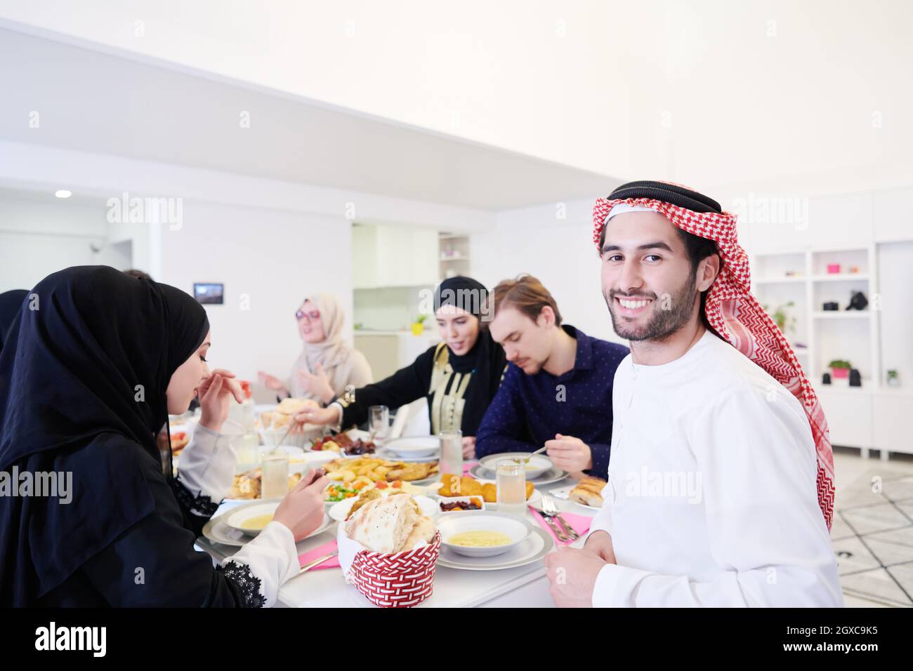 young arabian man having Iftar dinner with muslim family Eating ...