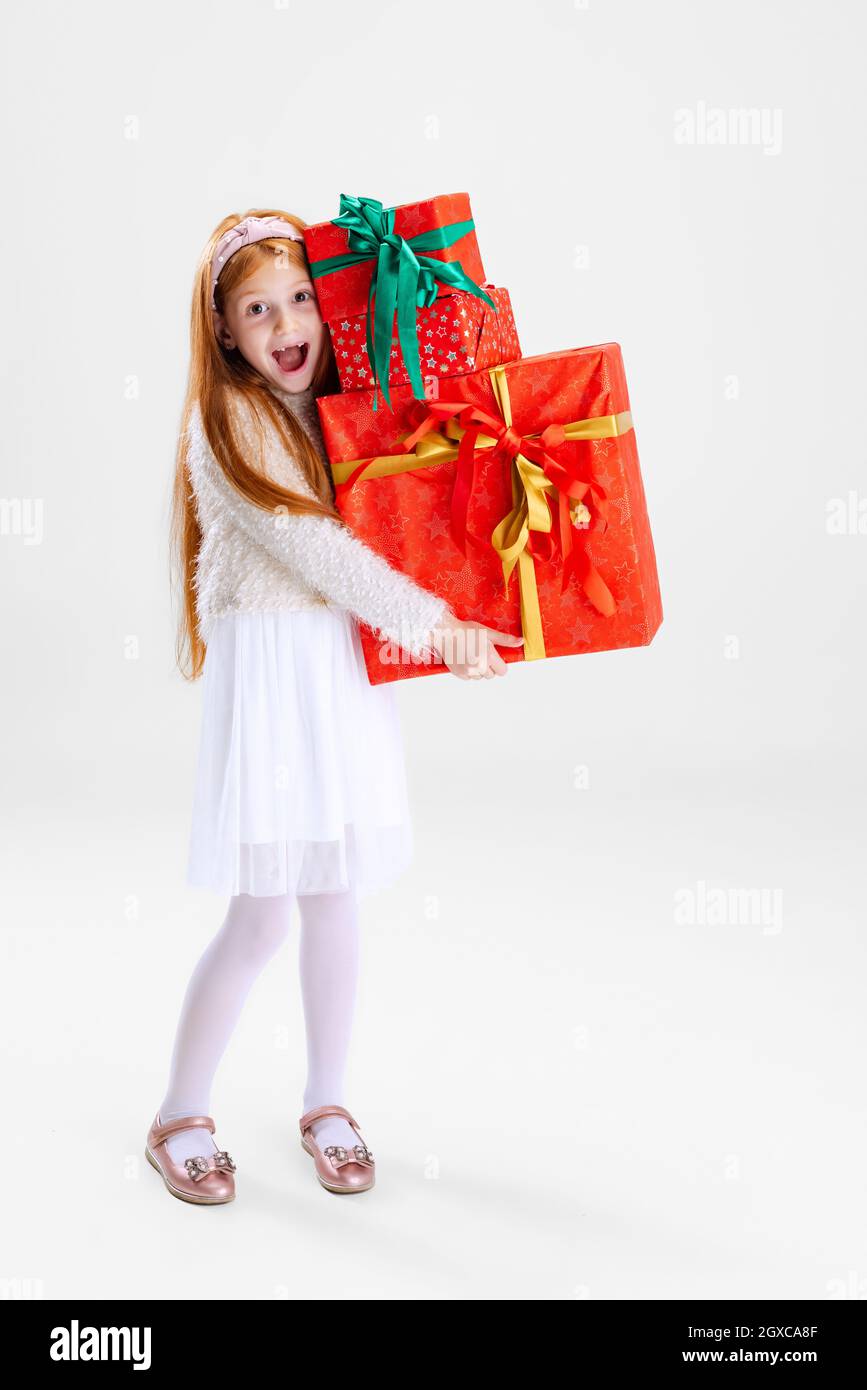 Full-length portrait of happy and delightful child, girl holding big ...