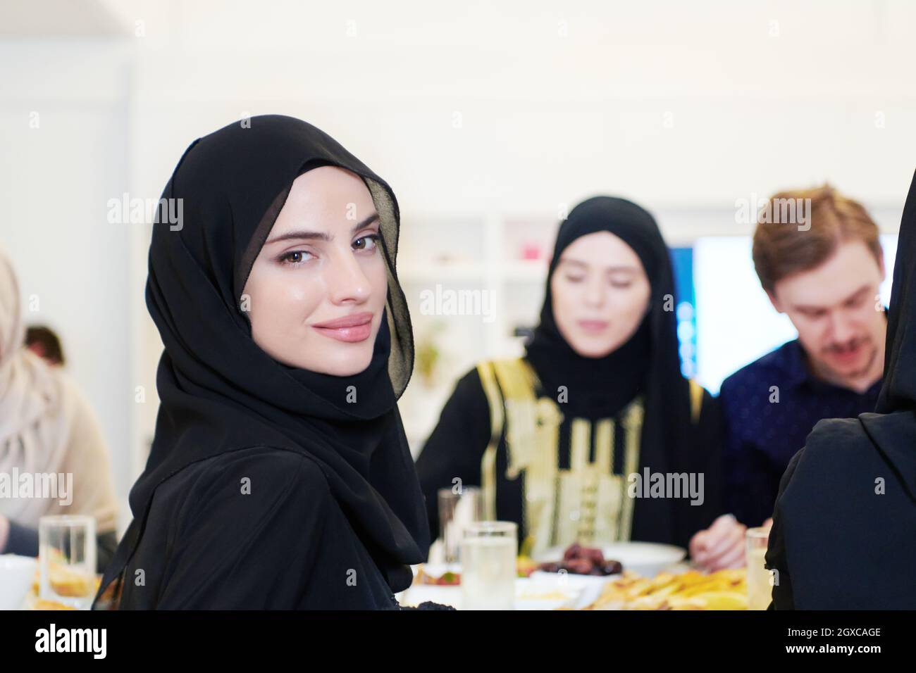 young muslim woman having Iftar dinner with family Eating traditional ...