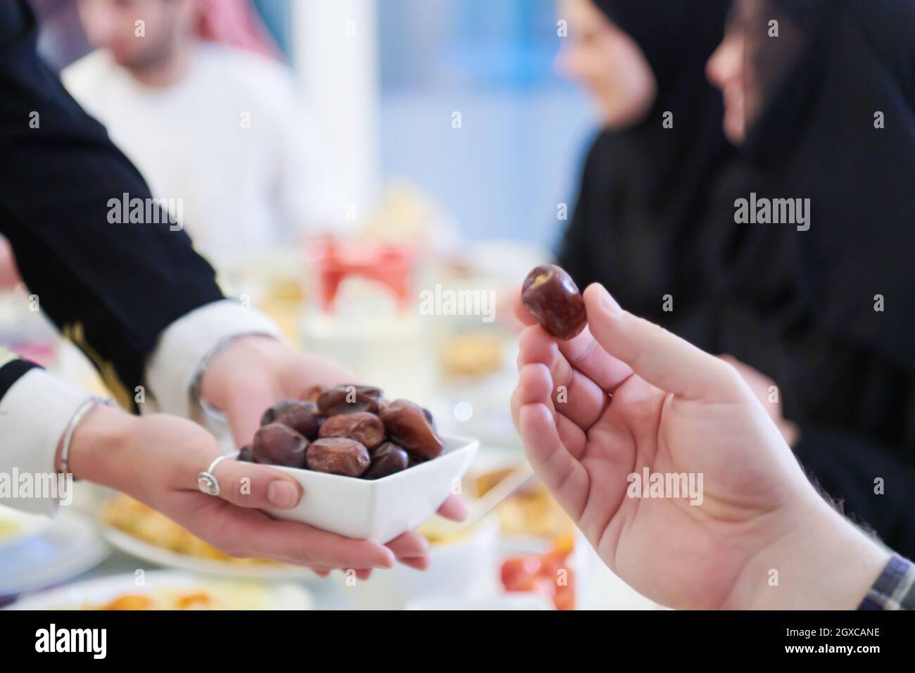 Eid Mubarak Muslim family having Iftar dinner eating dates to break ...