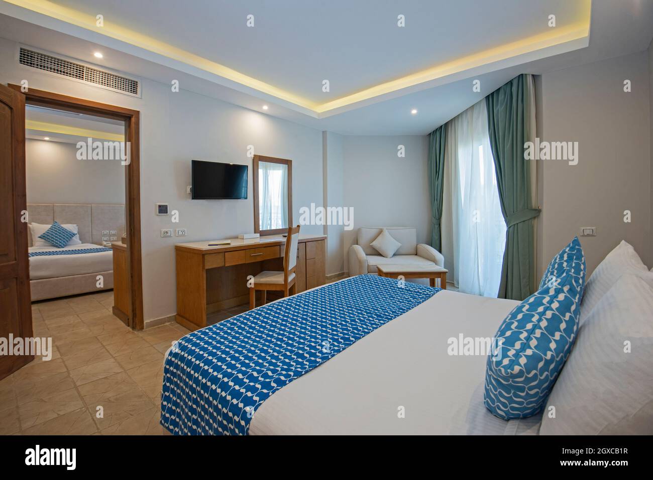 Double bed in family room suite of a luxury hotel with adjoining ...