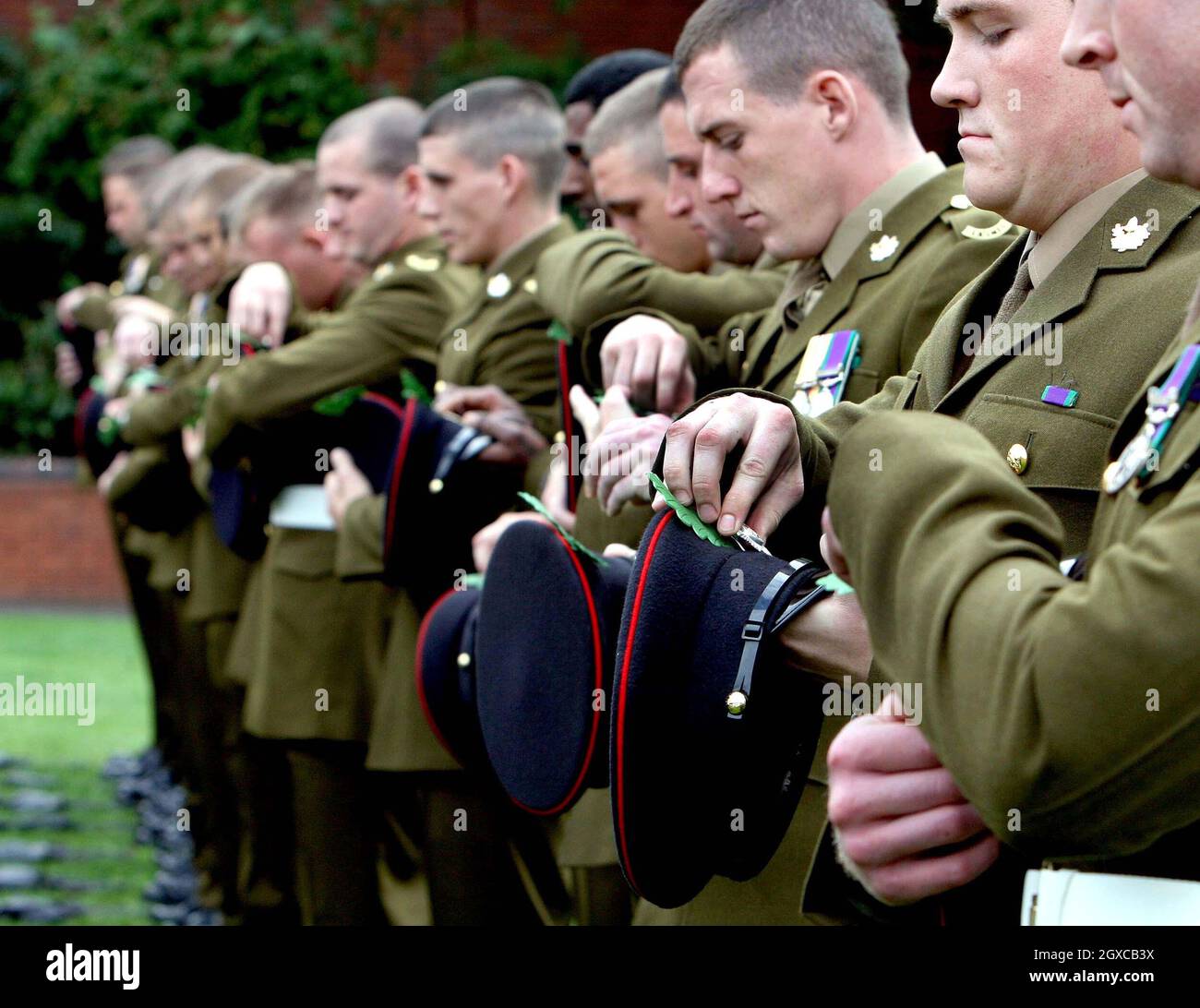 Soldiers of the new Mercian Regiment fix their new cap badge. The new ...