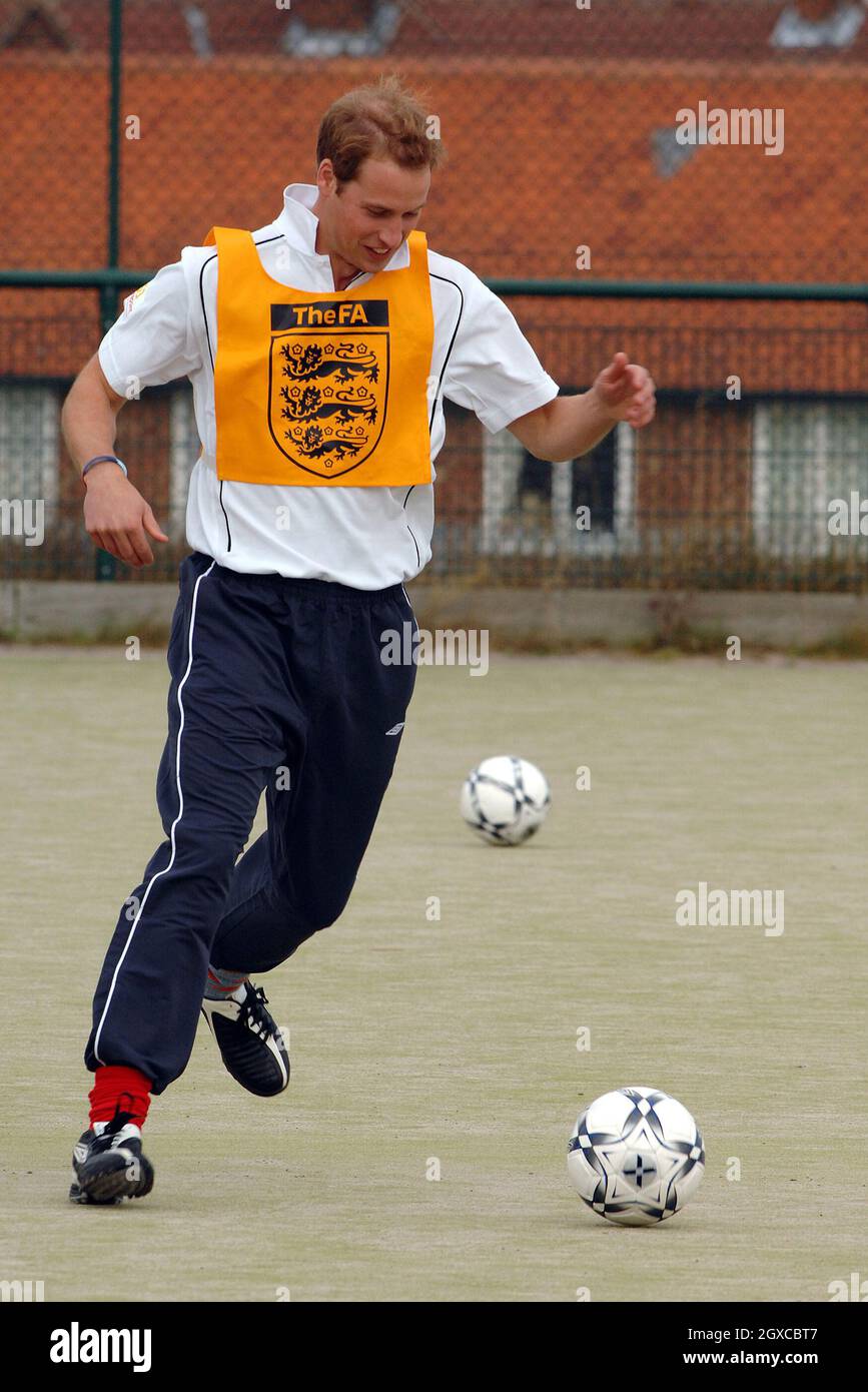 Prince William plays football with youngsters during a visit to the FA ...