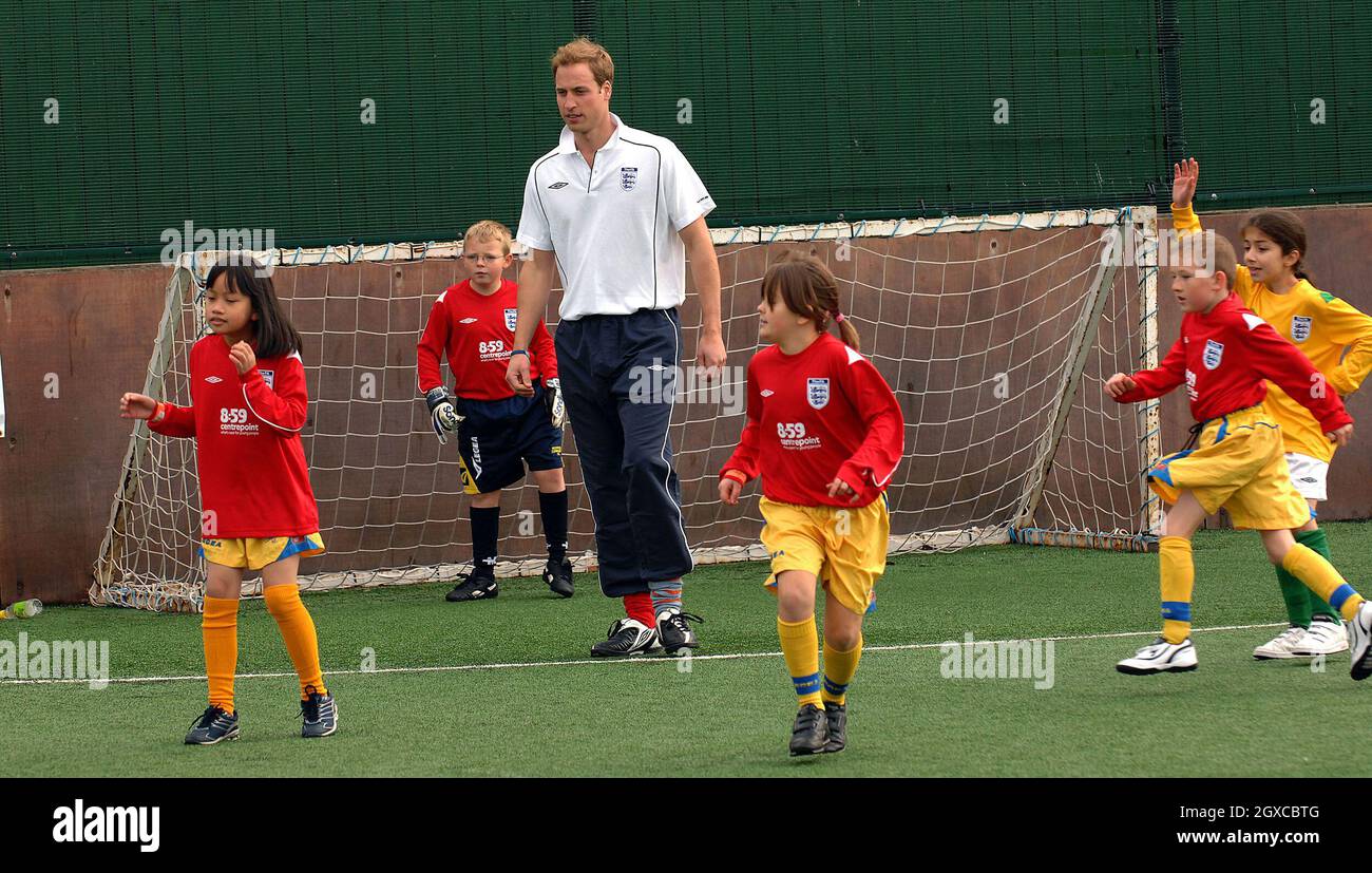 Prince William plays football with youngsters during a visit to the FA ...