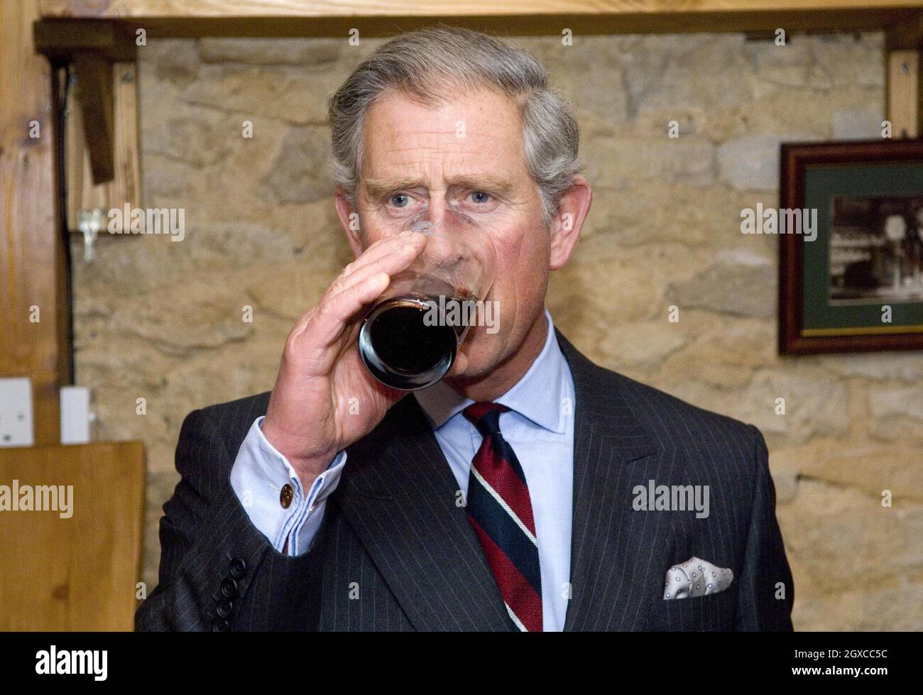 Prince Charles, Prince of Wales samples beer during a visit to Wychwood ...