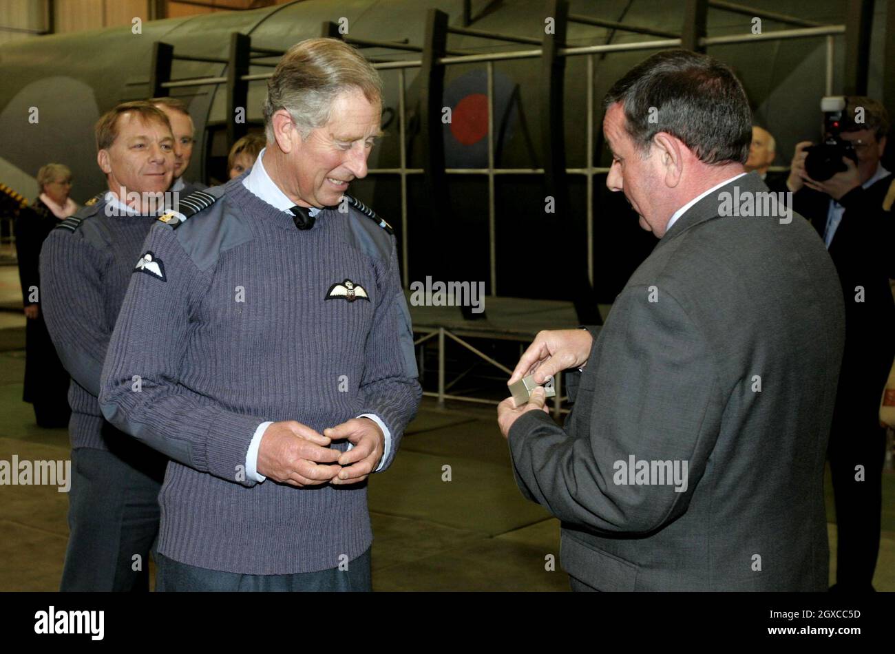 Prince Charles, Prince of Wales is presented with a lapel pin by Glan ...