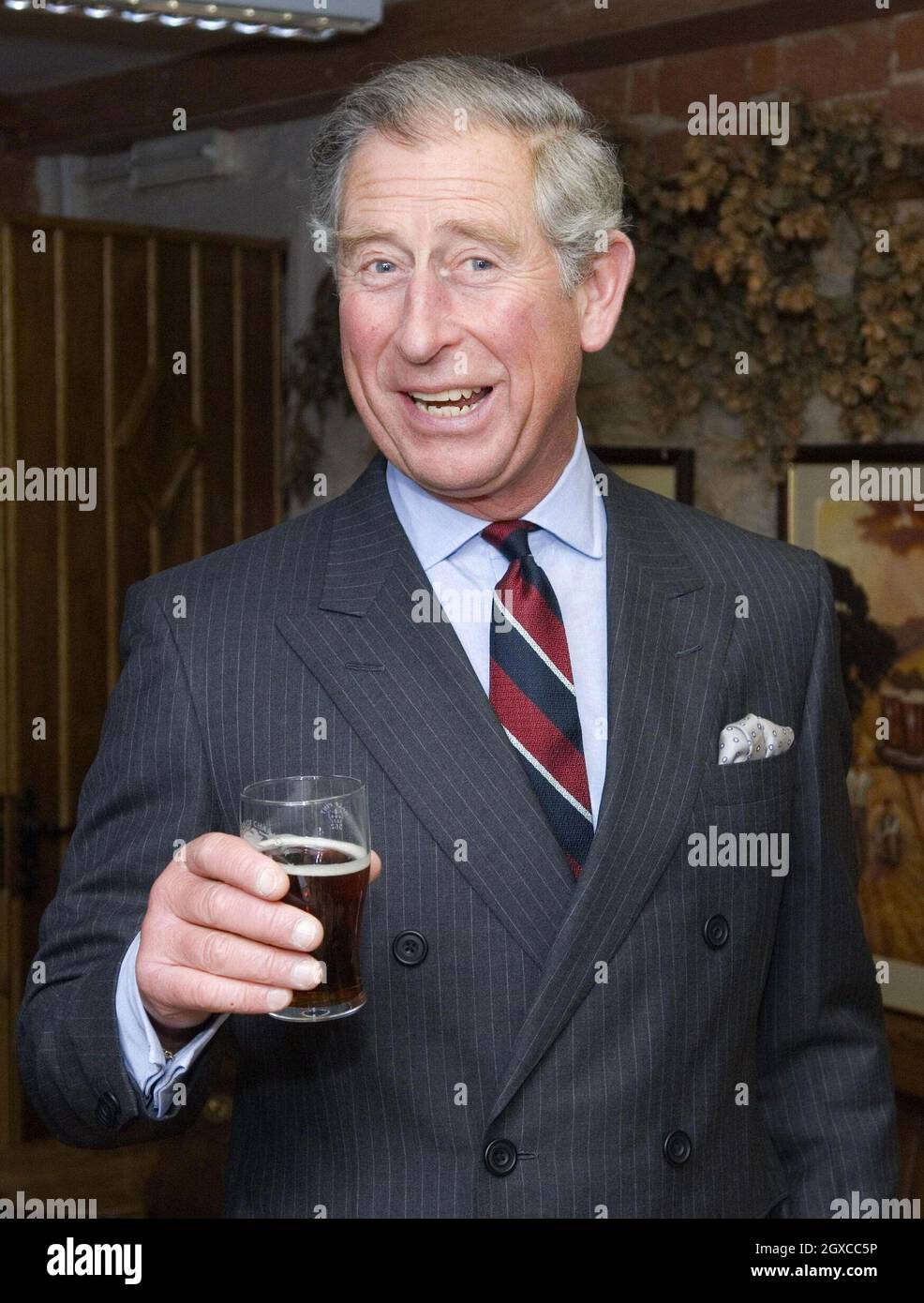 Prince Charles, Prince of Wales samples beer during a visit to Wychwood ...