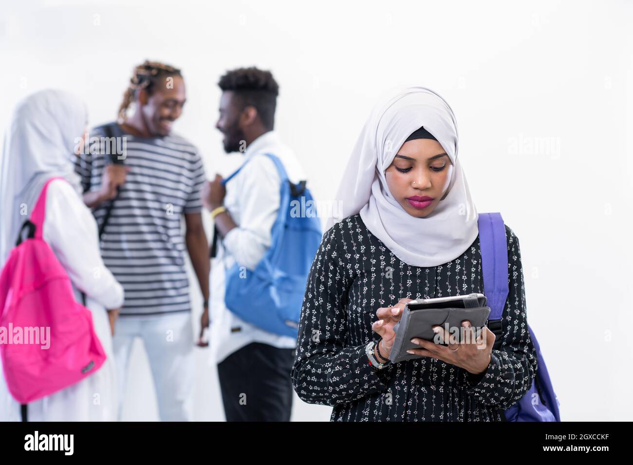 young african modern muslim female student using tablet computer with ...