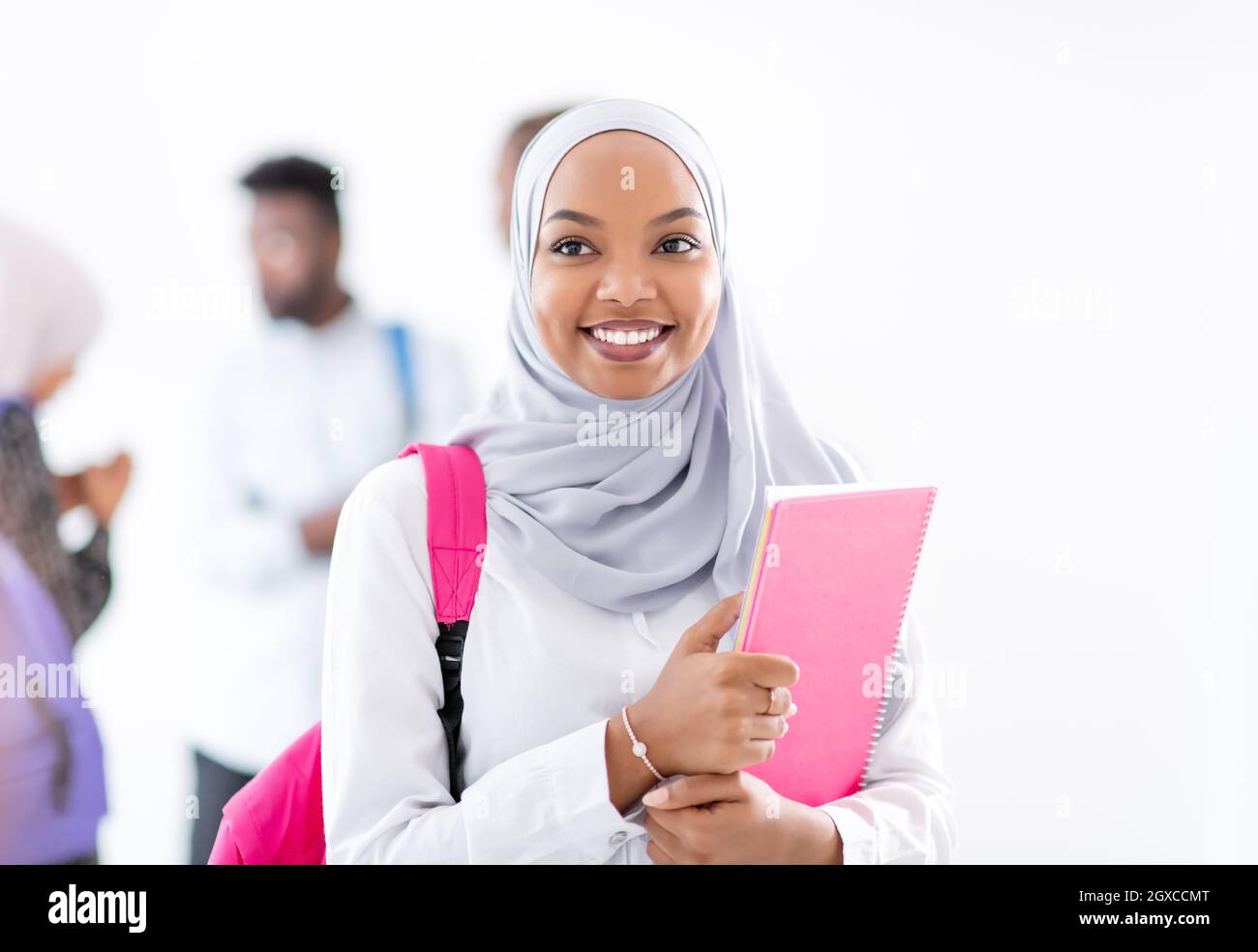portrait of young african modern muslim female student with group of ...