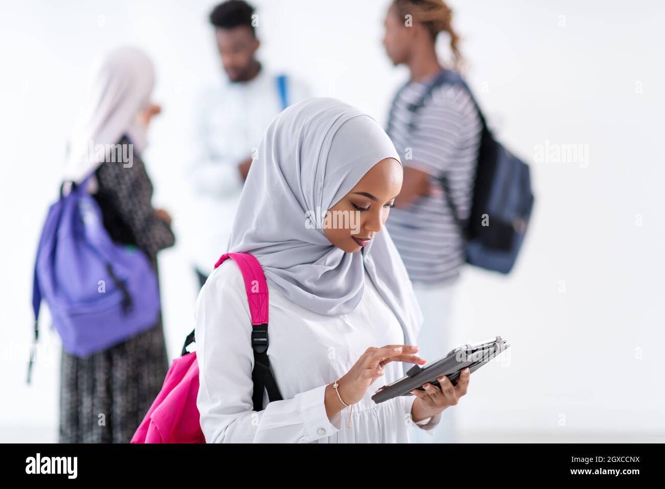 young african modern muslim female student using tablet computer with ...