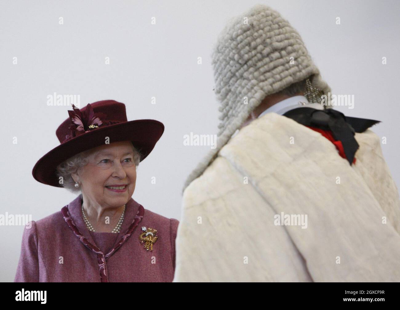 Queen Elizabeth II meets a judge during a visit to the new Criminal ...