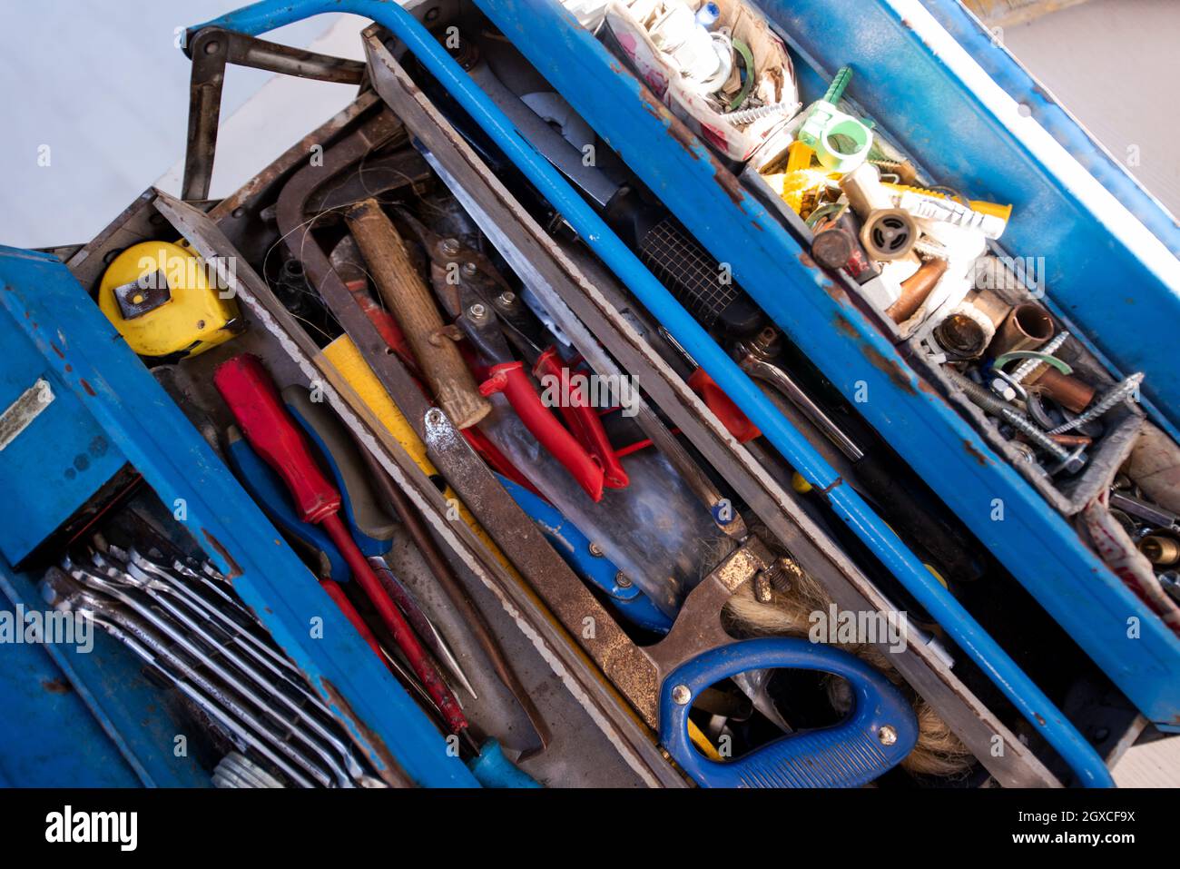 toolbox full of hand tools on real dusty floor background at construction site Stock Photo - Alamy