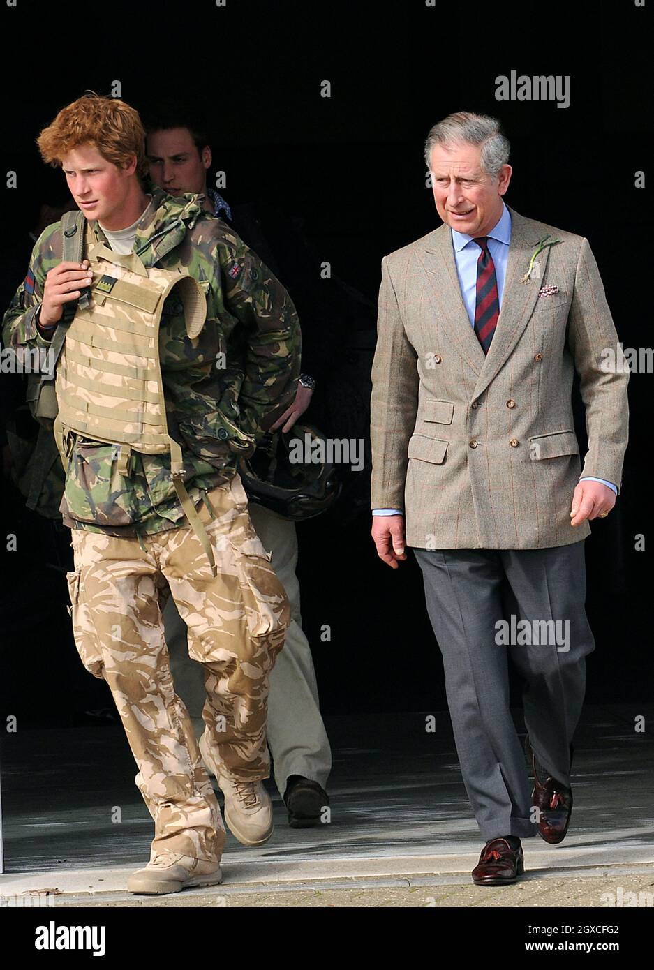 Prince Harry leaves the terminal at RAF Brize Norton with his father ...