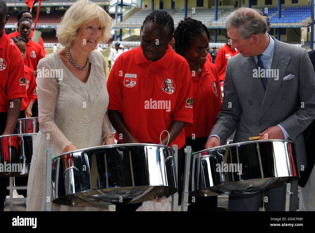 The Prince of Wales and The Duchess of Cornwall try out some tin drums ...