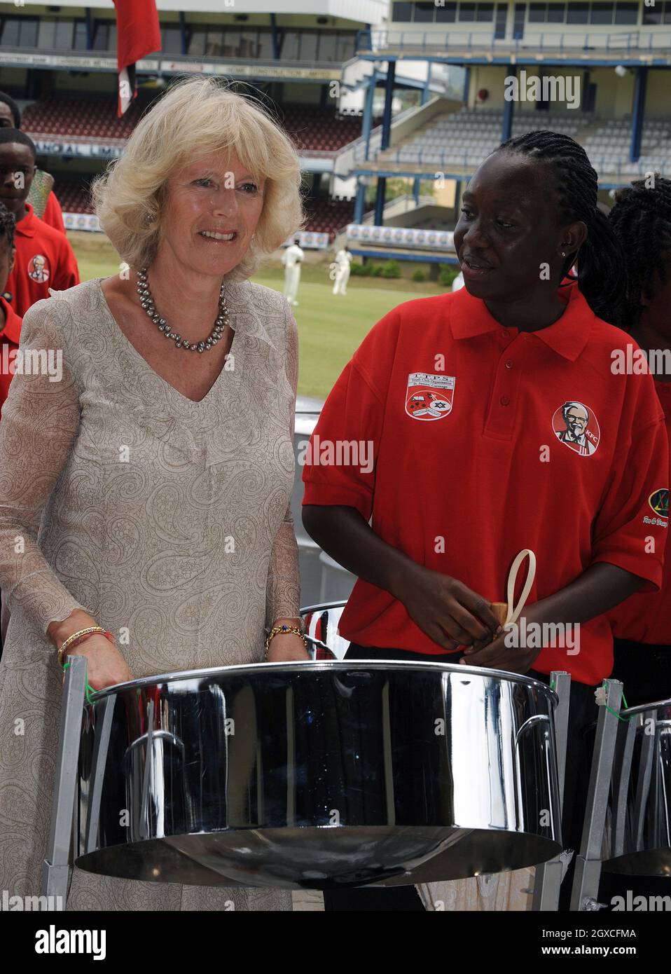 The Prince of Wales and The Duchess of Cornwall try out some tin drums ...